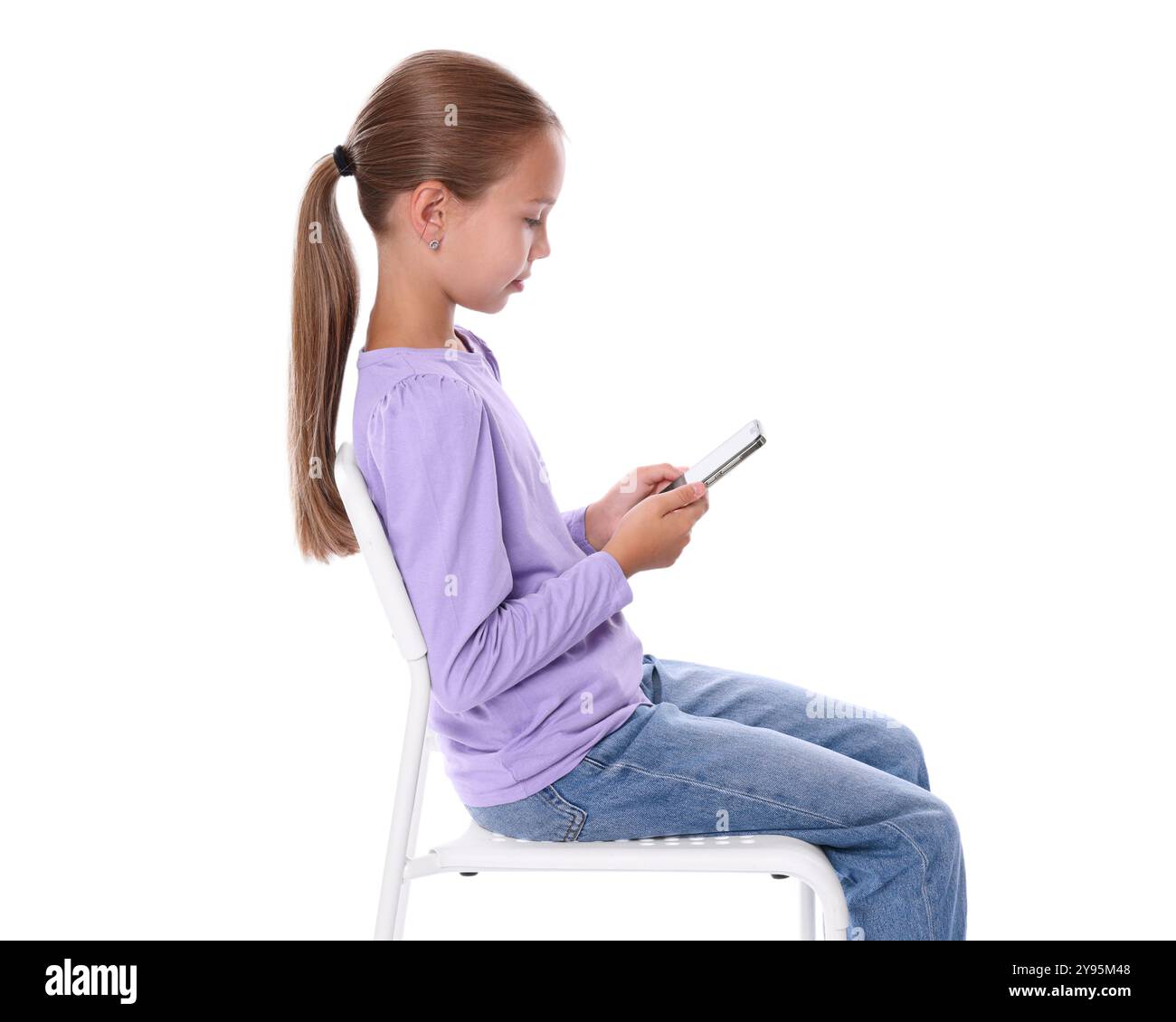 Girl with correct posture and smartphone sitting on white background ...