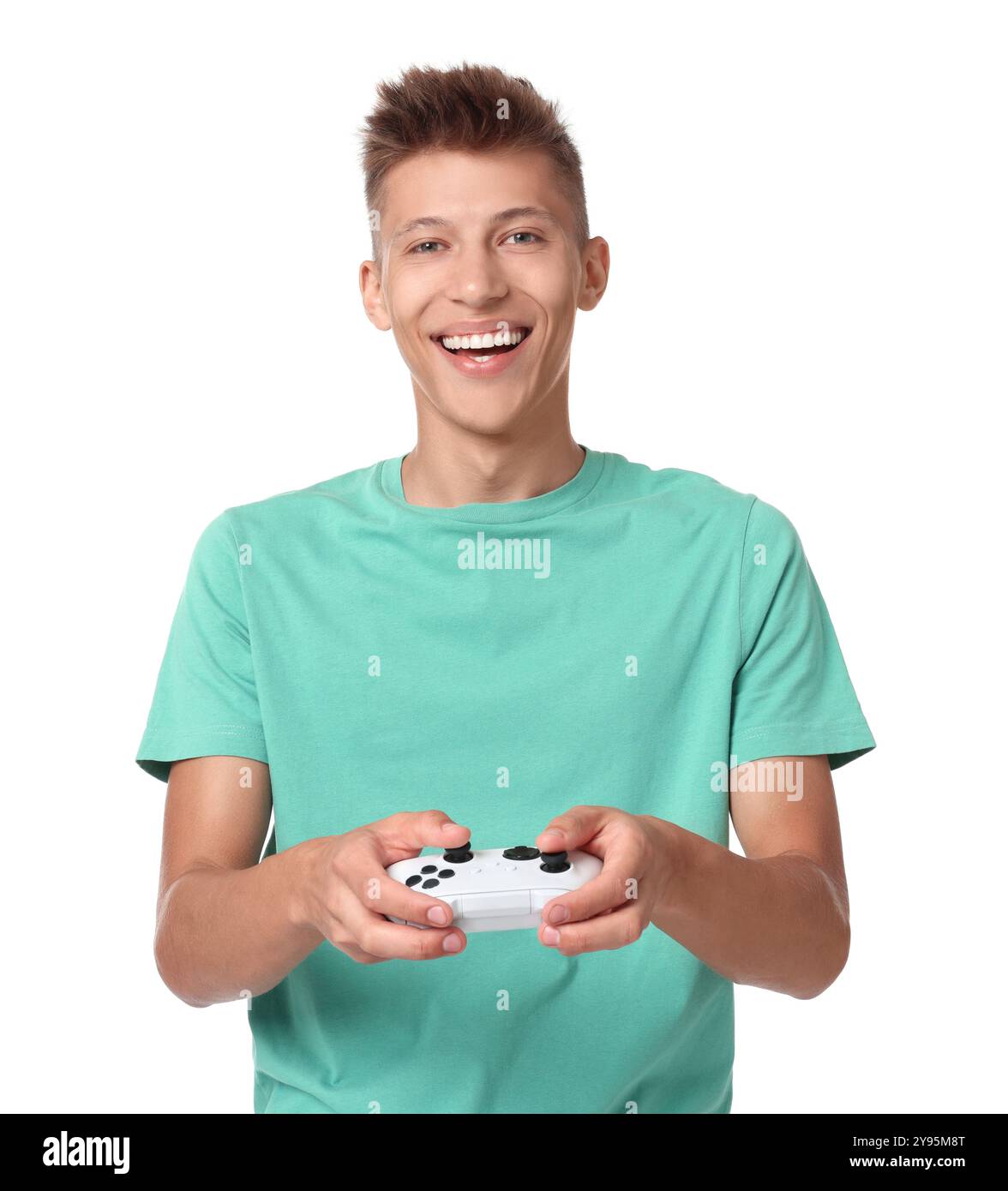 Happy young man playing video games with controller on white background ...