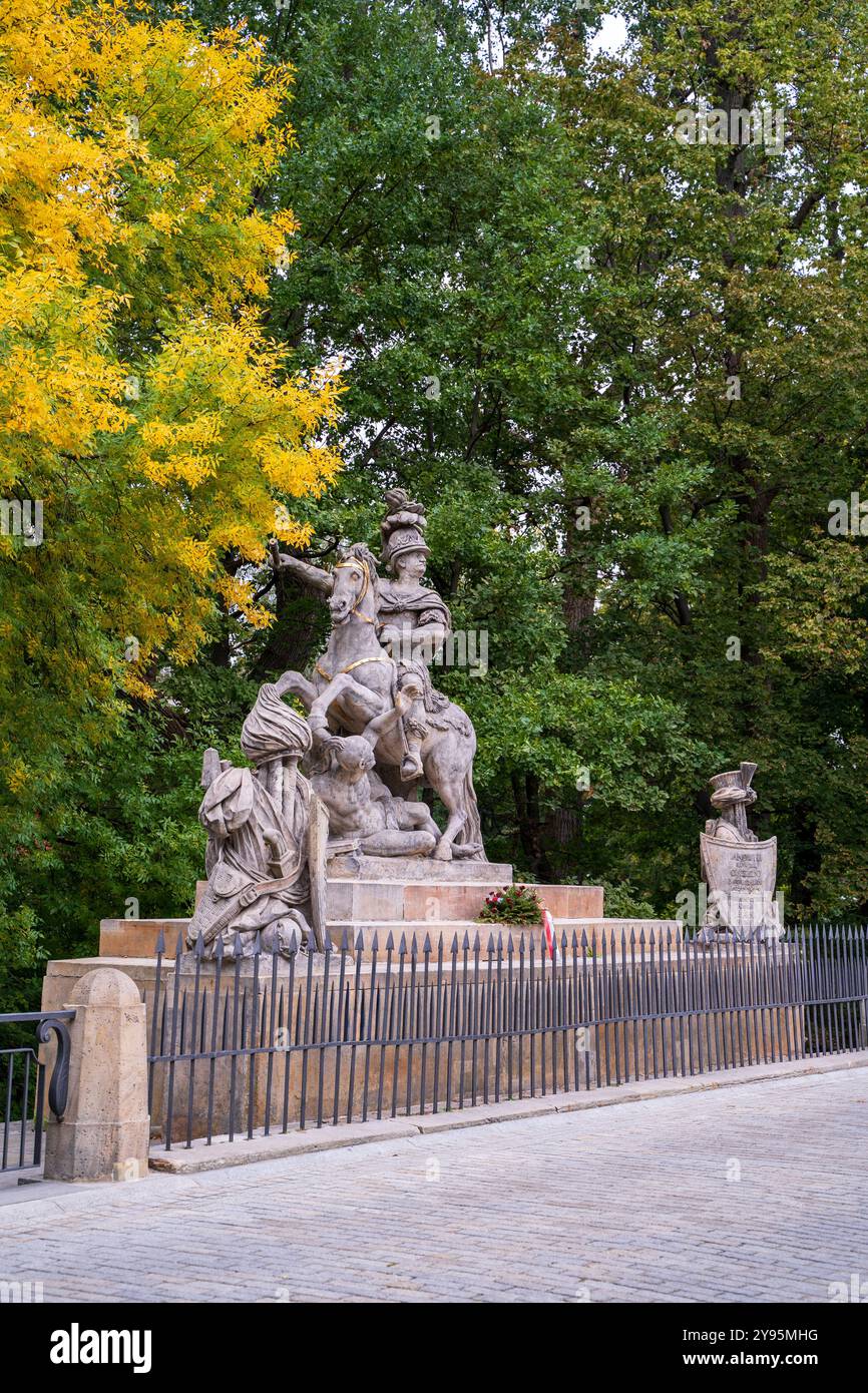 A dramatic stone monument featuring a rider on horseback is enveloped ...