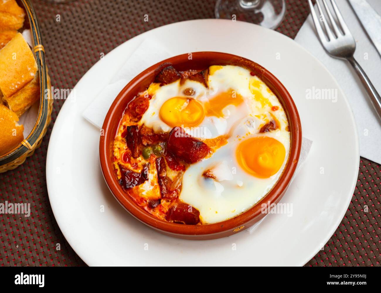 Popular spanish dish is fried eggs with chistorra Stock Photo - Alamy