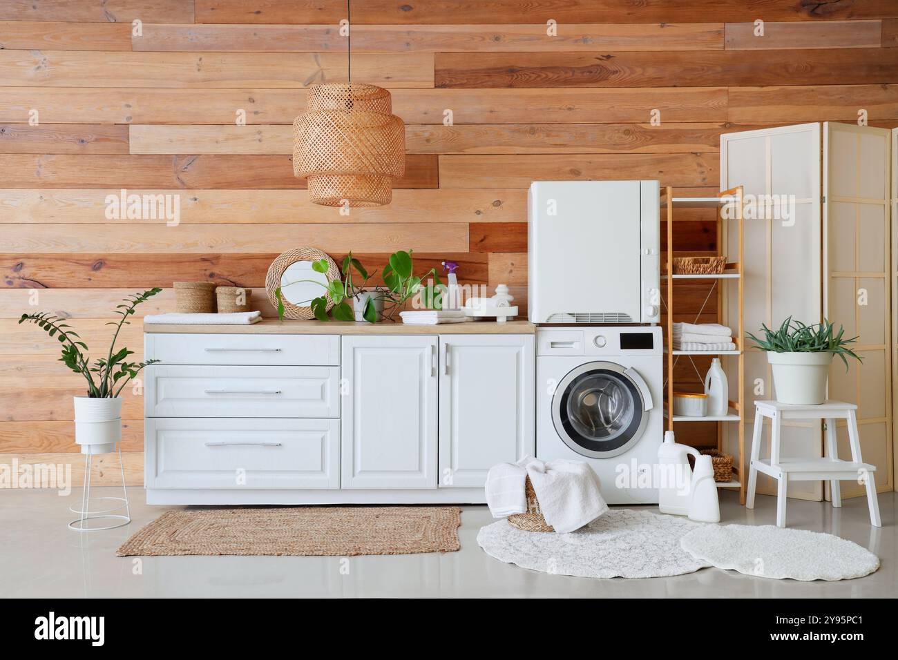 Interior of home laundry room with modern washing machine, counter ...