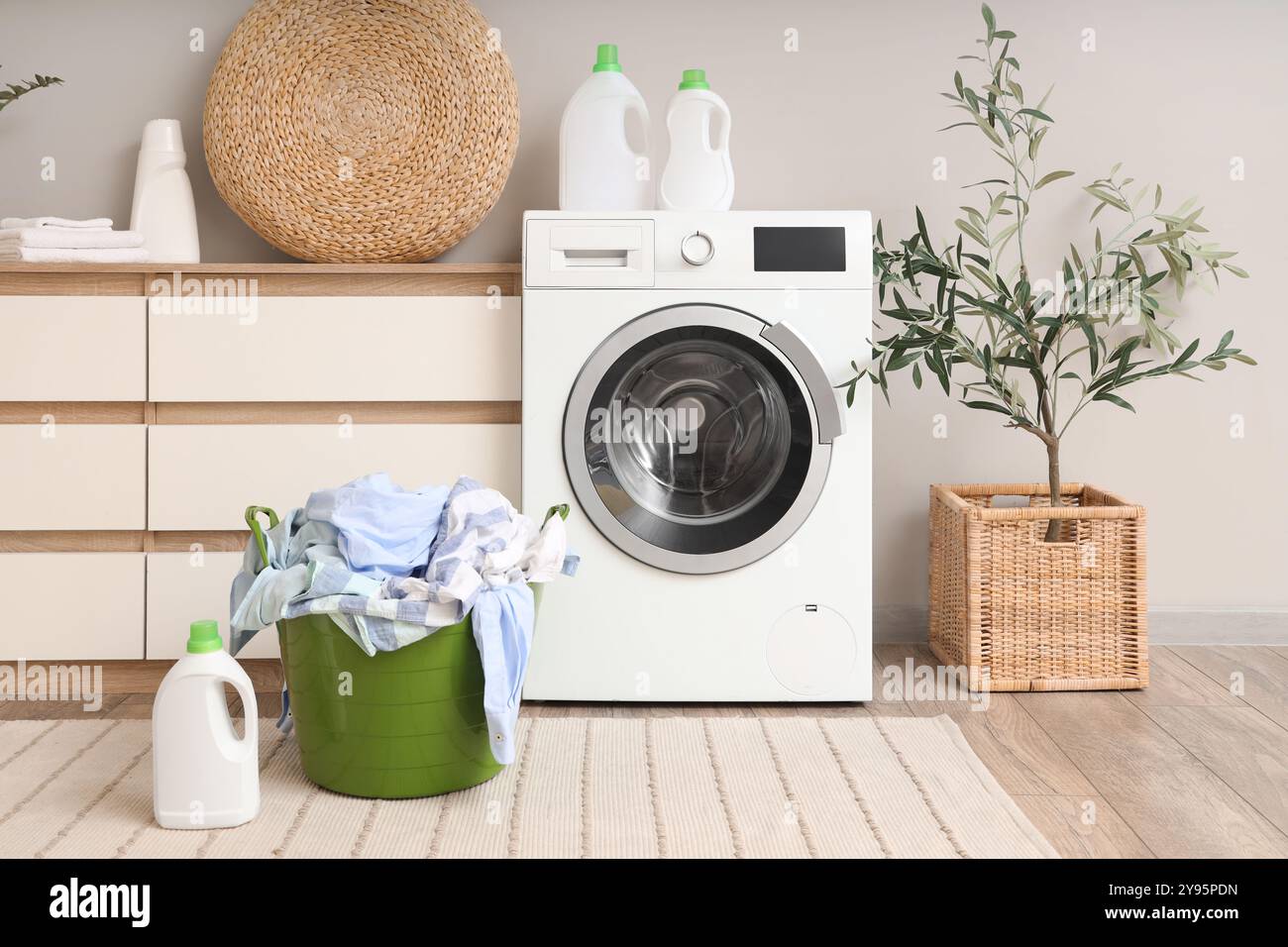 Interior of home laundry room with washing machine, chest of drawers ...