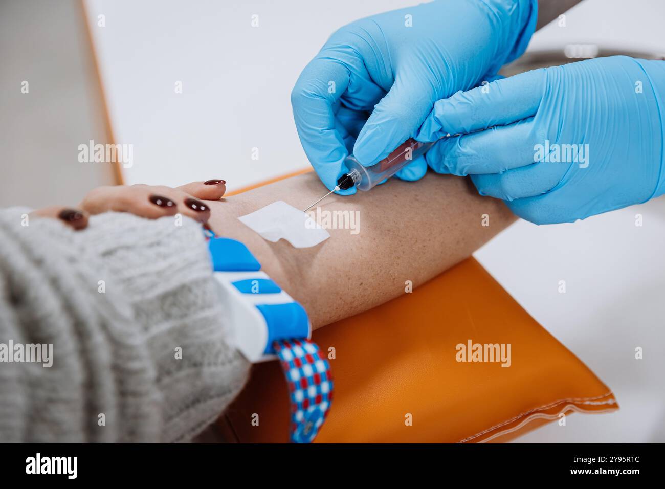 Healthcare professional drawing blood from patient for medical test ...