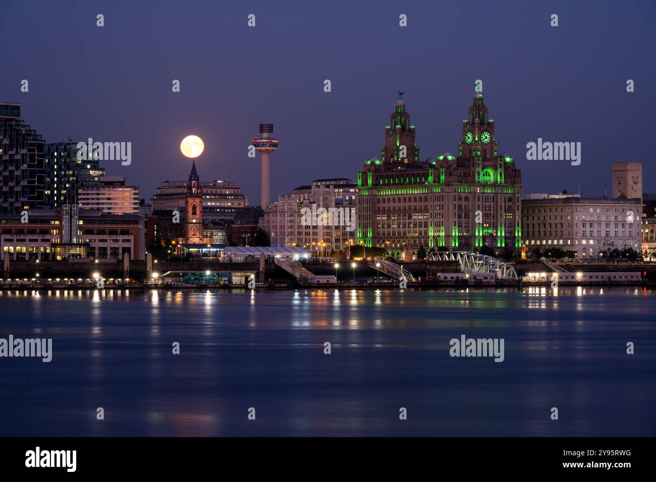 A full moon rises over the River Mersey and the skyline of Liverpool ...