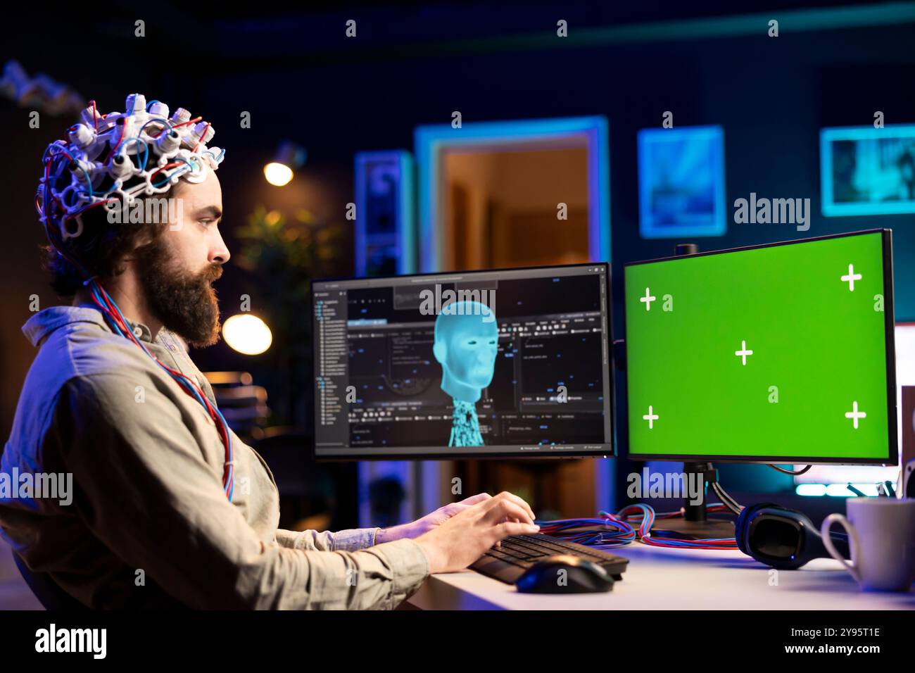 Software engineer with EEG headset starting mind upload on green screen PC, trying to gain ...