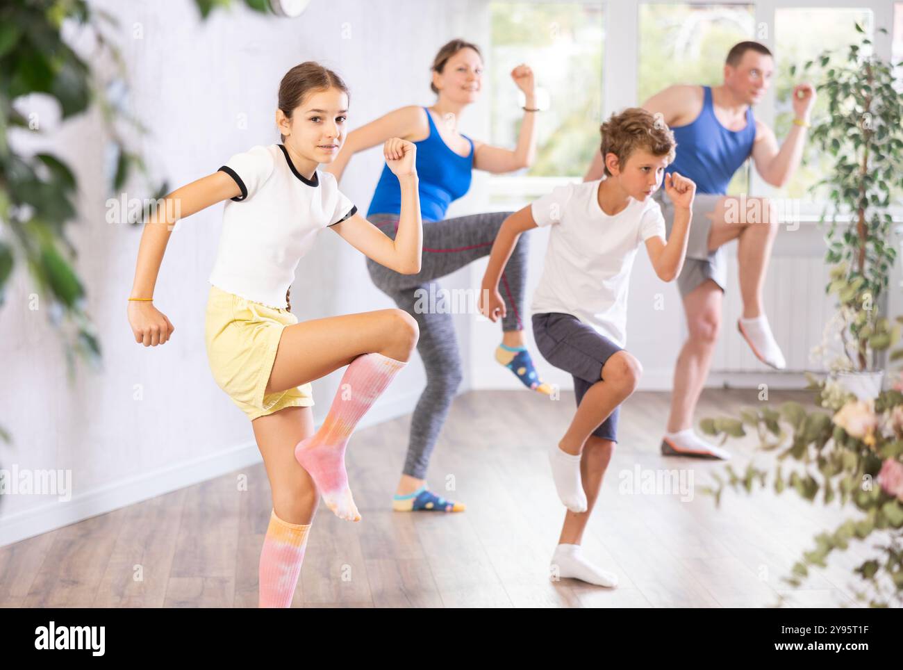 Parents together with their children learn how to dance salsa or boogie ...