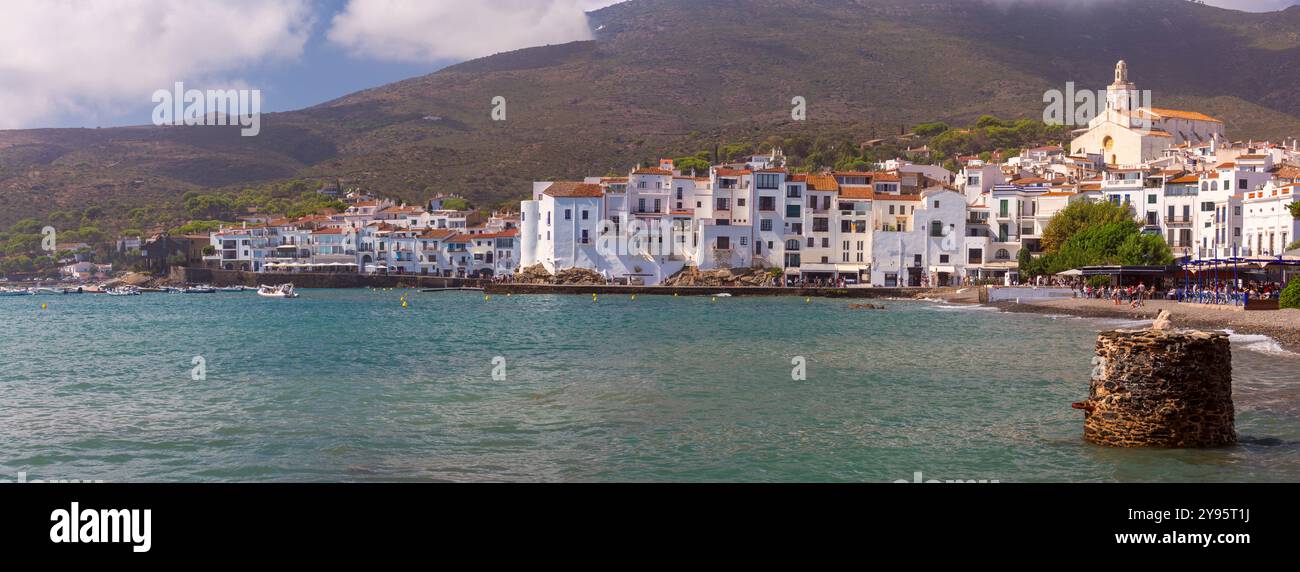 Panoramic view of Cadaques with whitewashed houses along the coast and ...