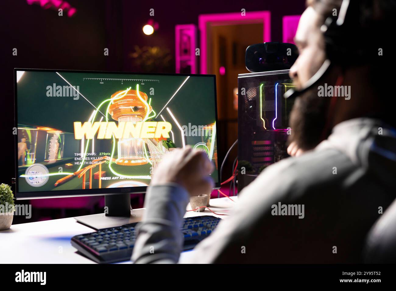 Happy pro gamer at home competing in intense multiplayer videogame ...