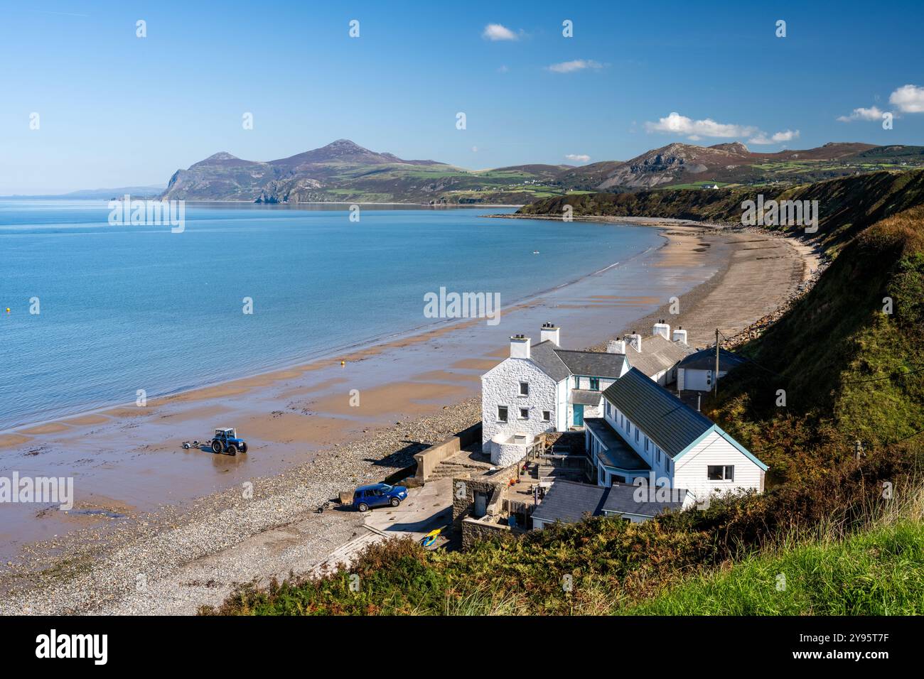 Yr Eifl hill rises behind the sweep of Traeth Morfa Nefyn beach and ...