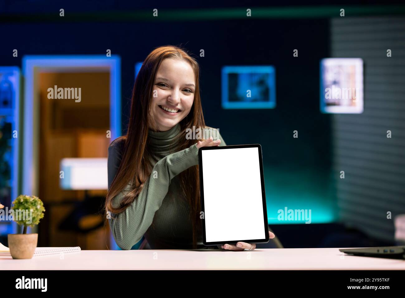 Cheerful teenage girl excited to review mockup tablet, comparing ...