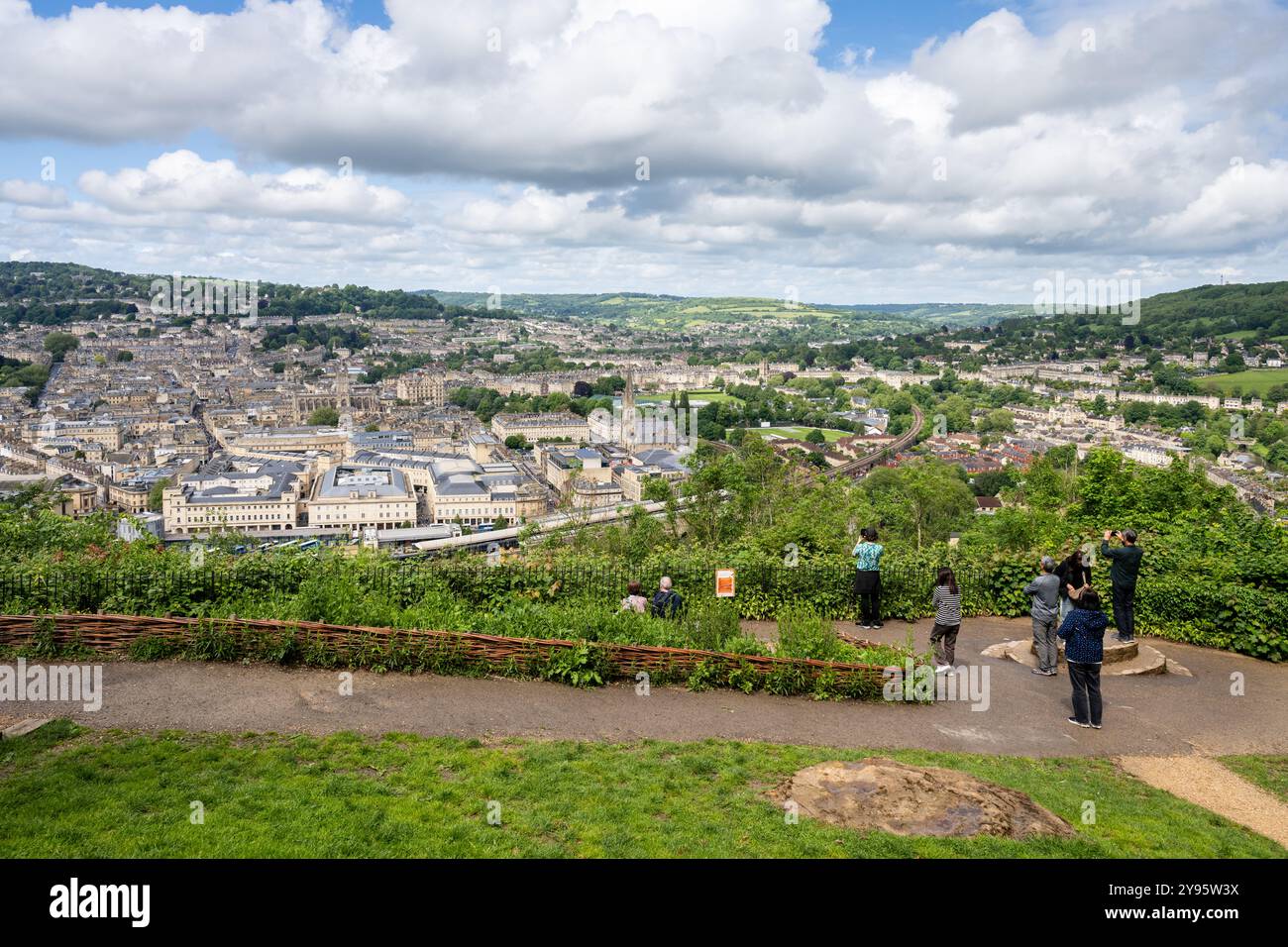 Tourists look out across the cityscape of Bath in Somerset from ...