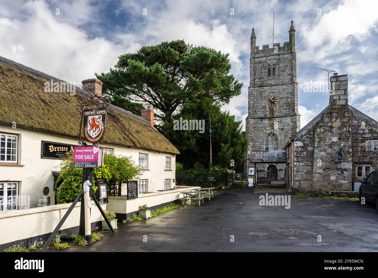 The traditional parish church of the Holy Trinity and thatched Drewe ...