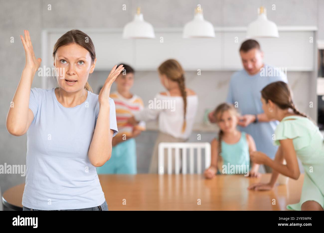 Irritated mom is tired of noise and screams of the children at home ...