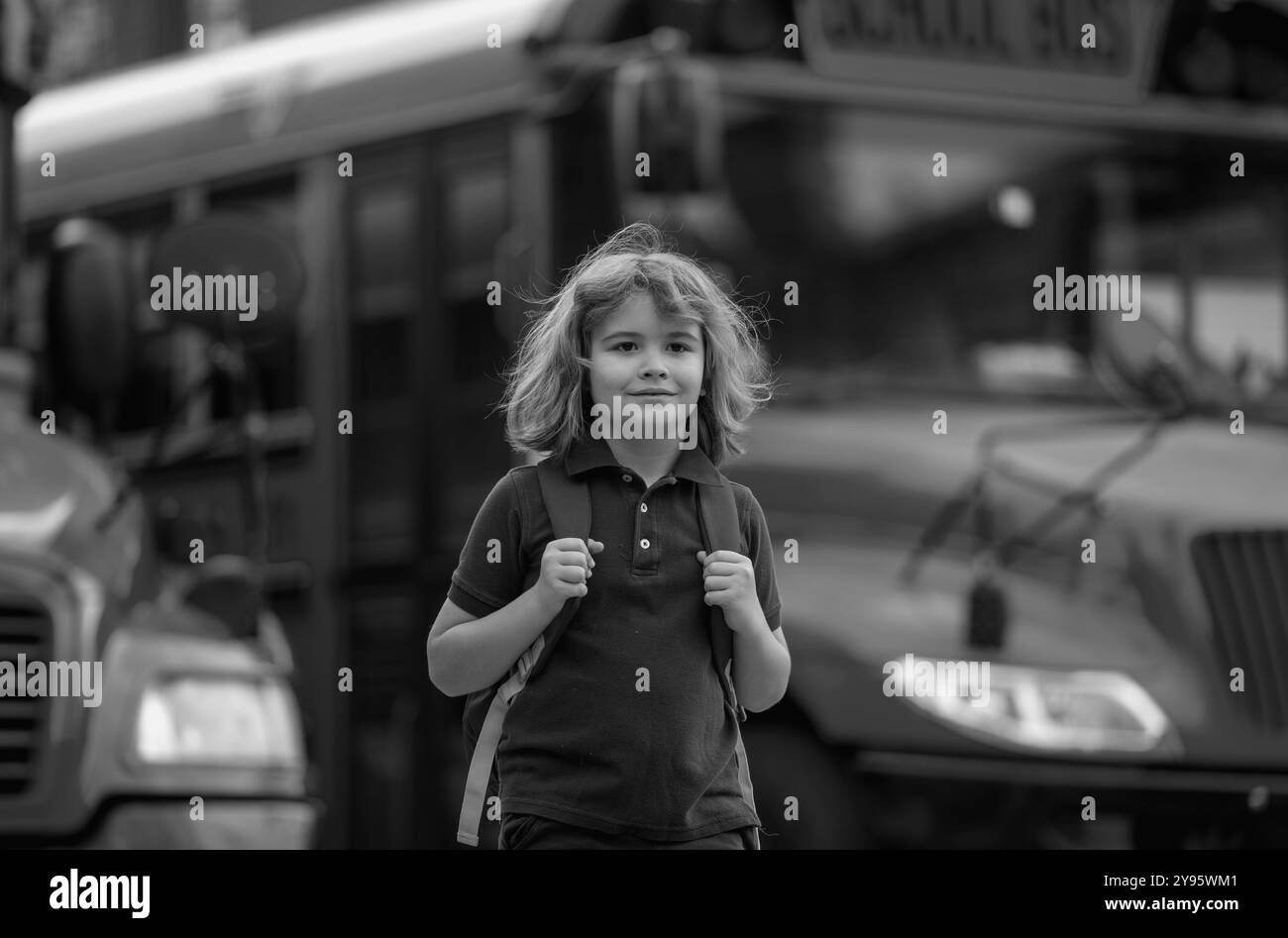 Schoolkid getting on the school bus. American School. Back to school ...