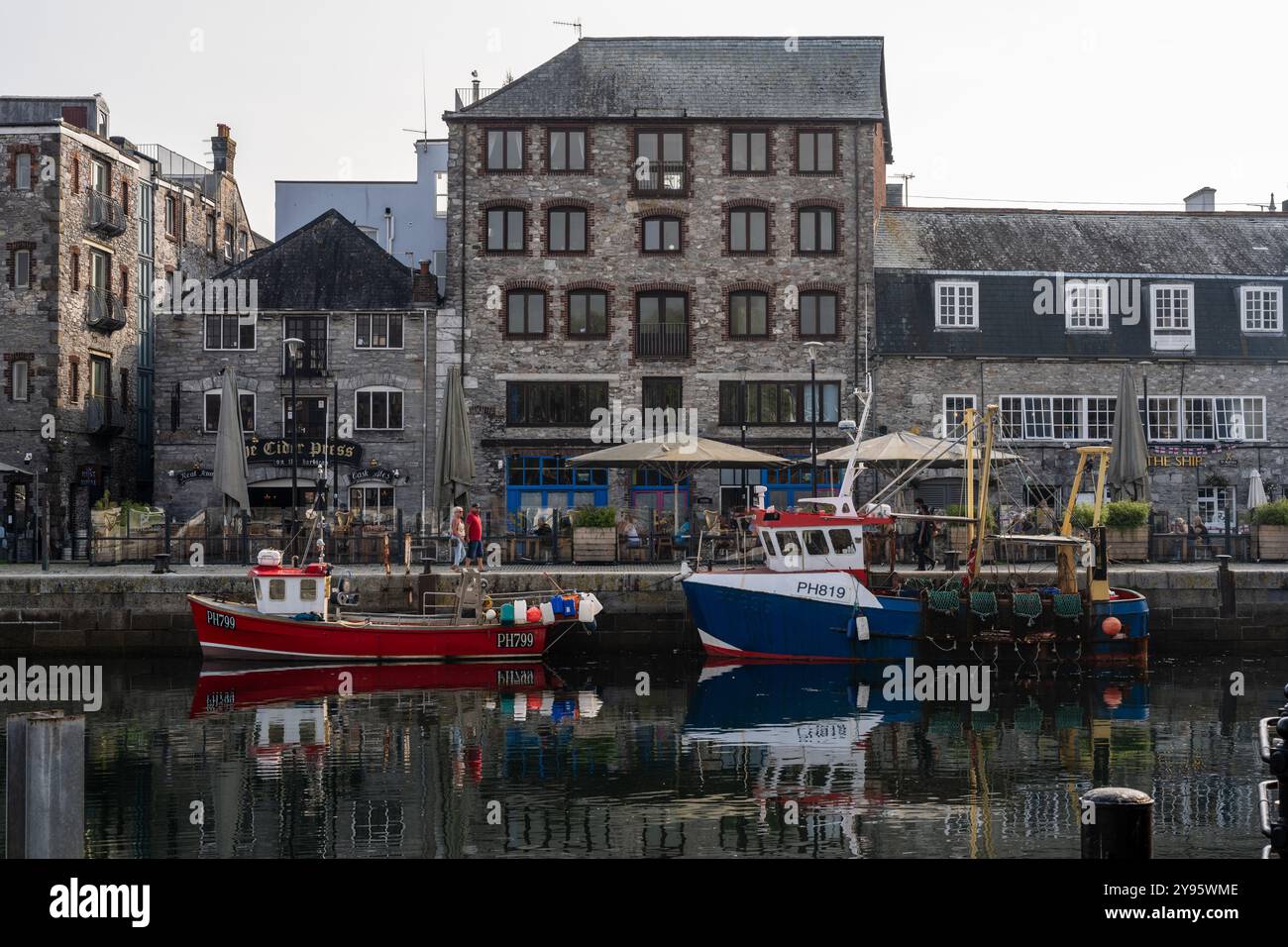 Fishing boats are moored in Sutton Harbour in the Barbican area of ...