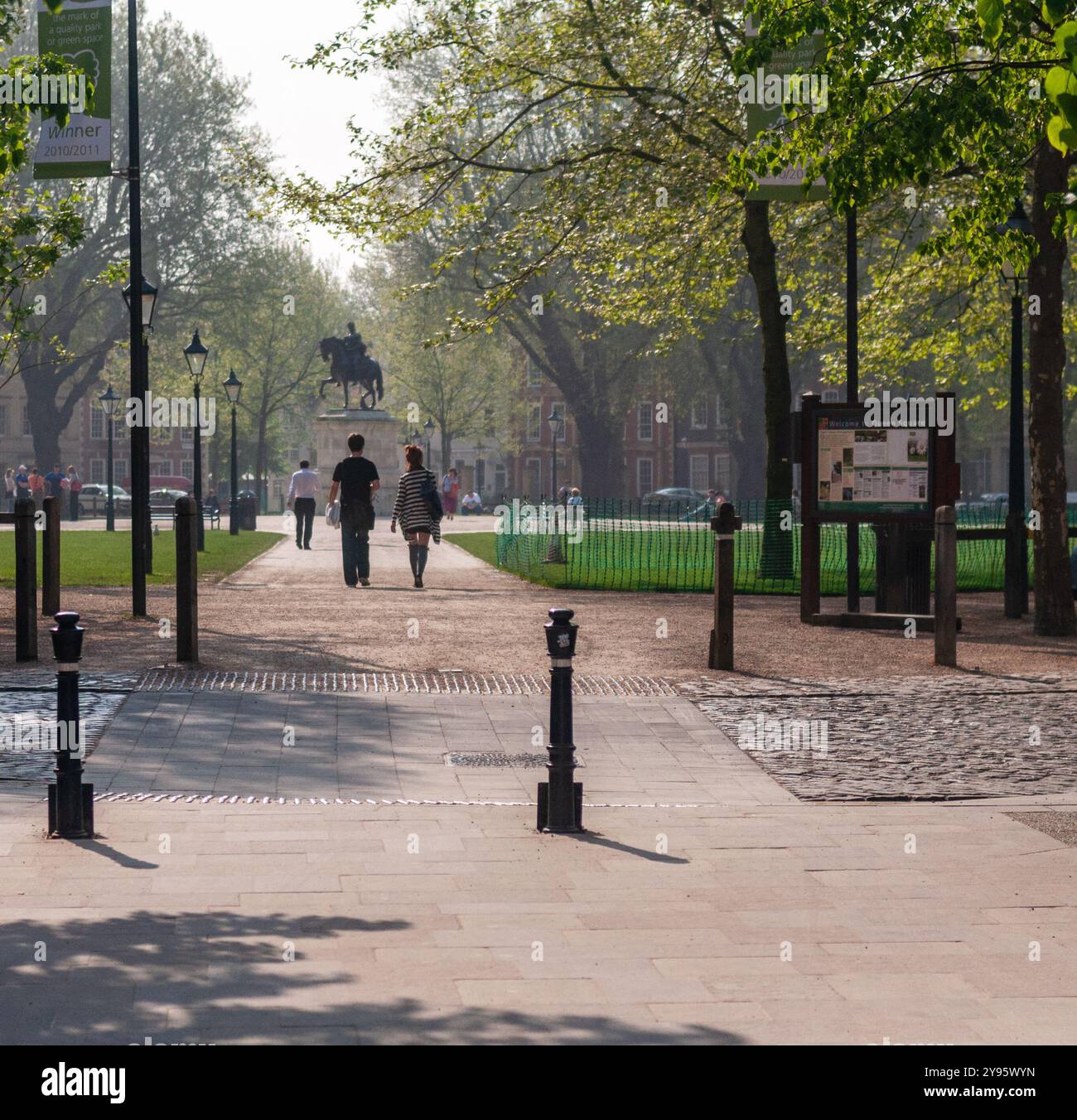 Pedestrians walk through the Georgian Queen Square in Bristol's city ...