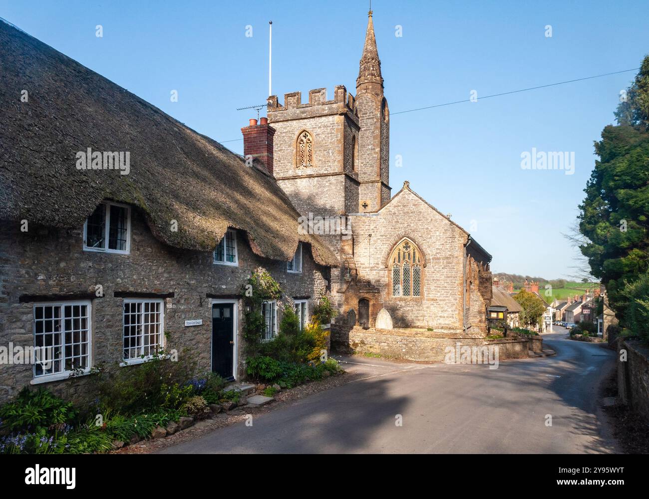 Shun shines on traditional thatched cottages and the parish church of ...
