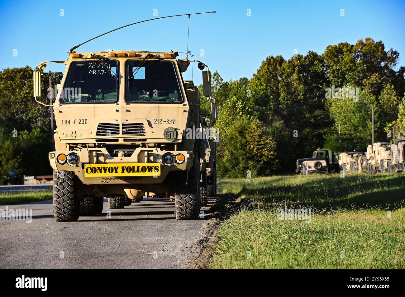 U.S. Army National Guard dump trucks and other government vehicles line ...