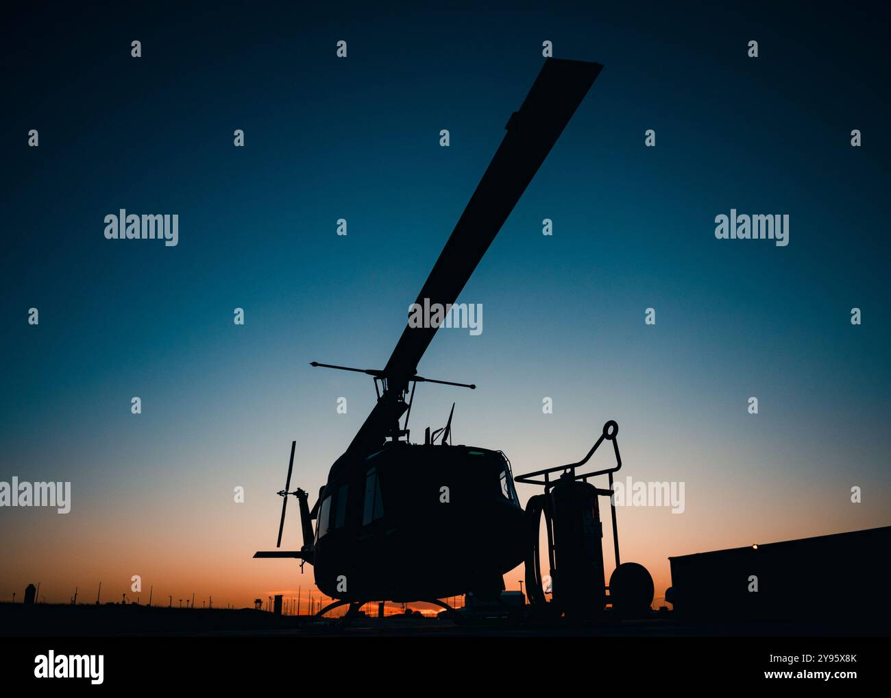 A UH-1N Huey attached to the 37th Helicopter Squadron sits on a helipad ...