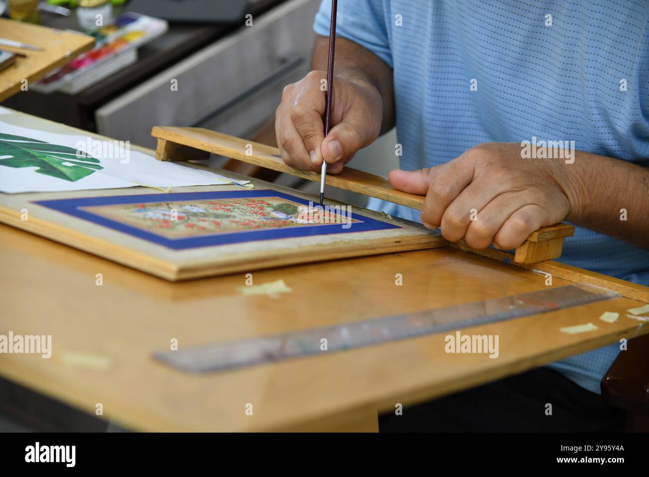 Hands of artist painting miniature with traditional uzbek motive on ...