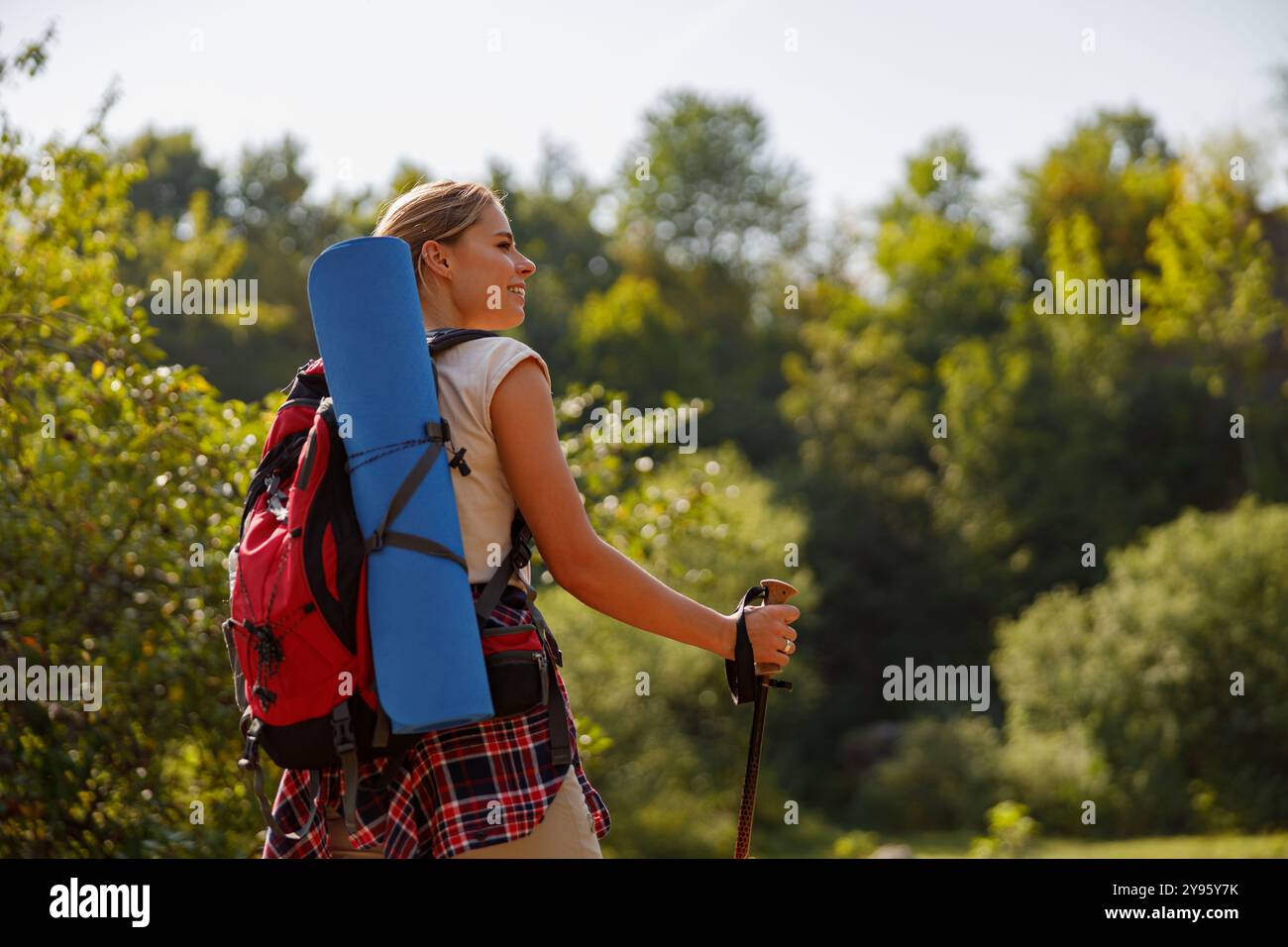 A Hiker equipped with a Backpack and Camping Gear Trekking on a ...
