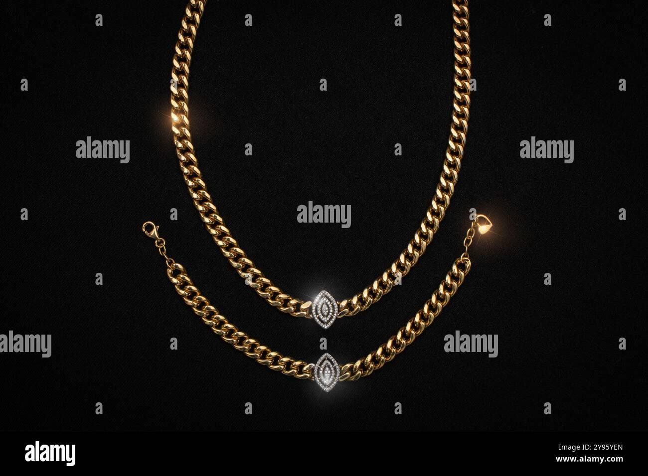 A matching set of gold chain necklace and bracelet featuring a ...