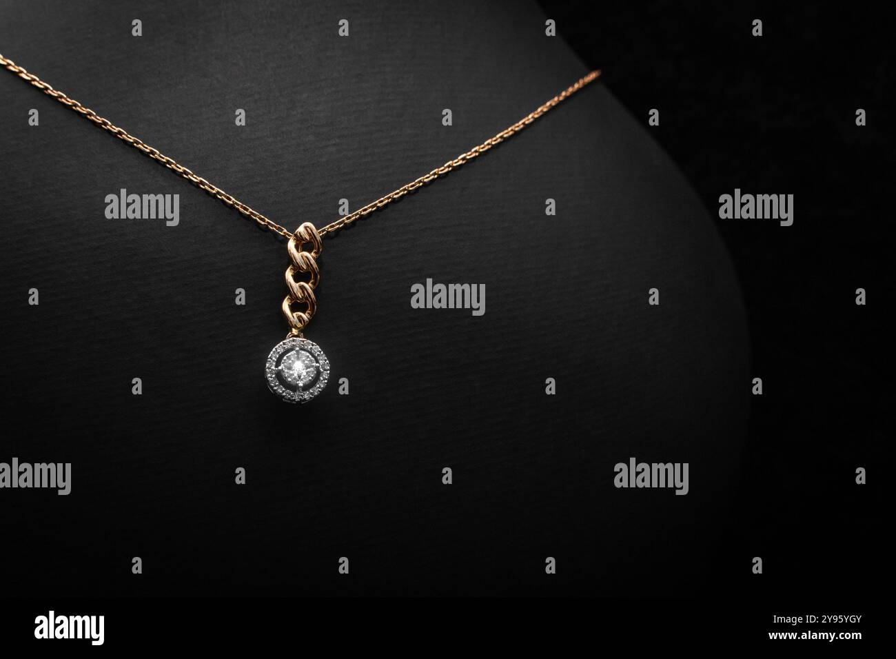 A delicate single diamond pendant necklace, featuring a circular ...