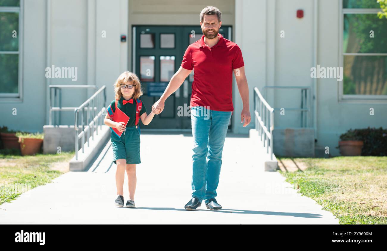 Outdoor school. School boy going to school with father. Parent with ...
