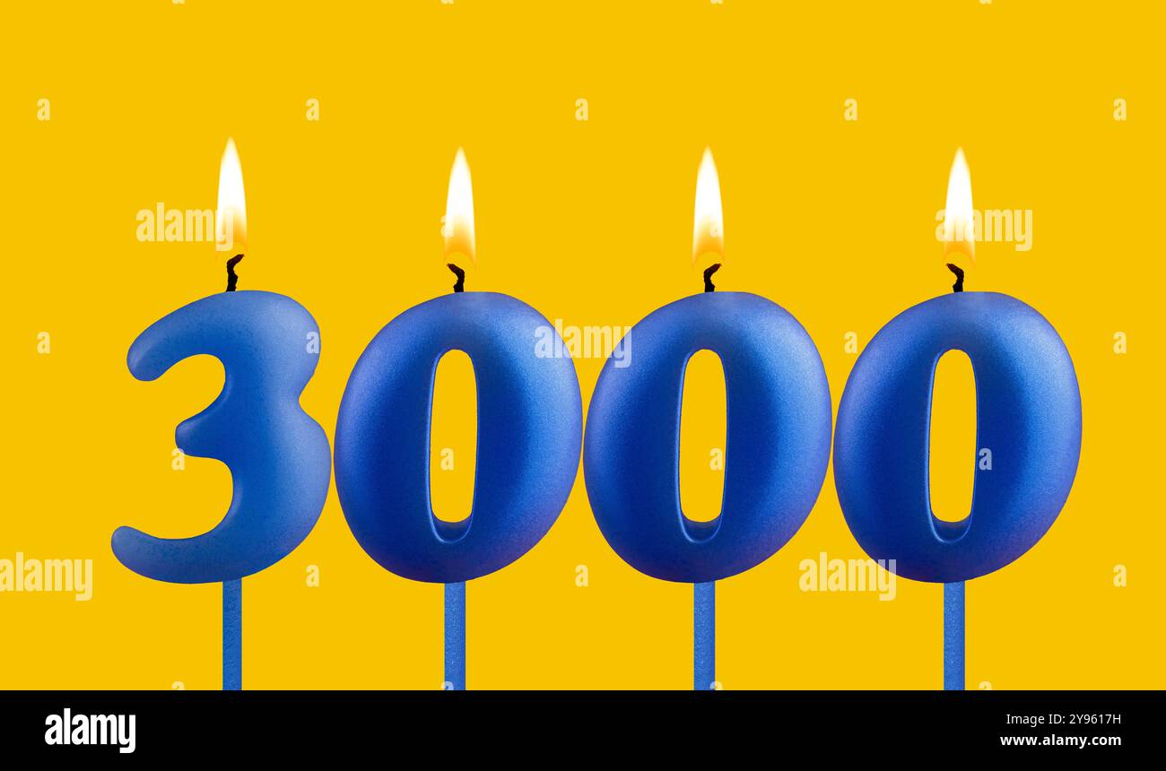 Blue candle number 3000 - Birthday on yellow background Stock Photo - Alamy