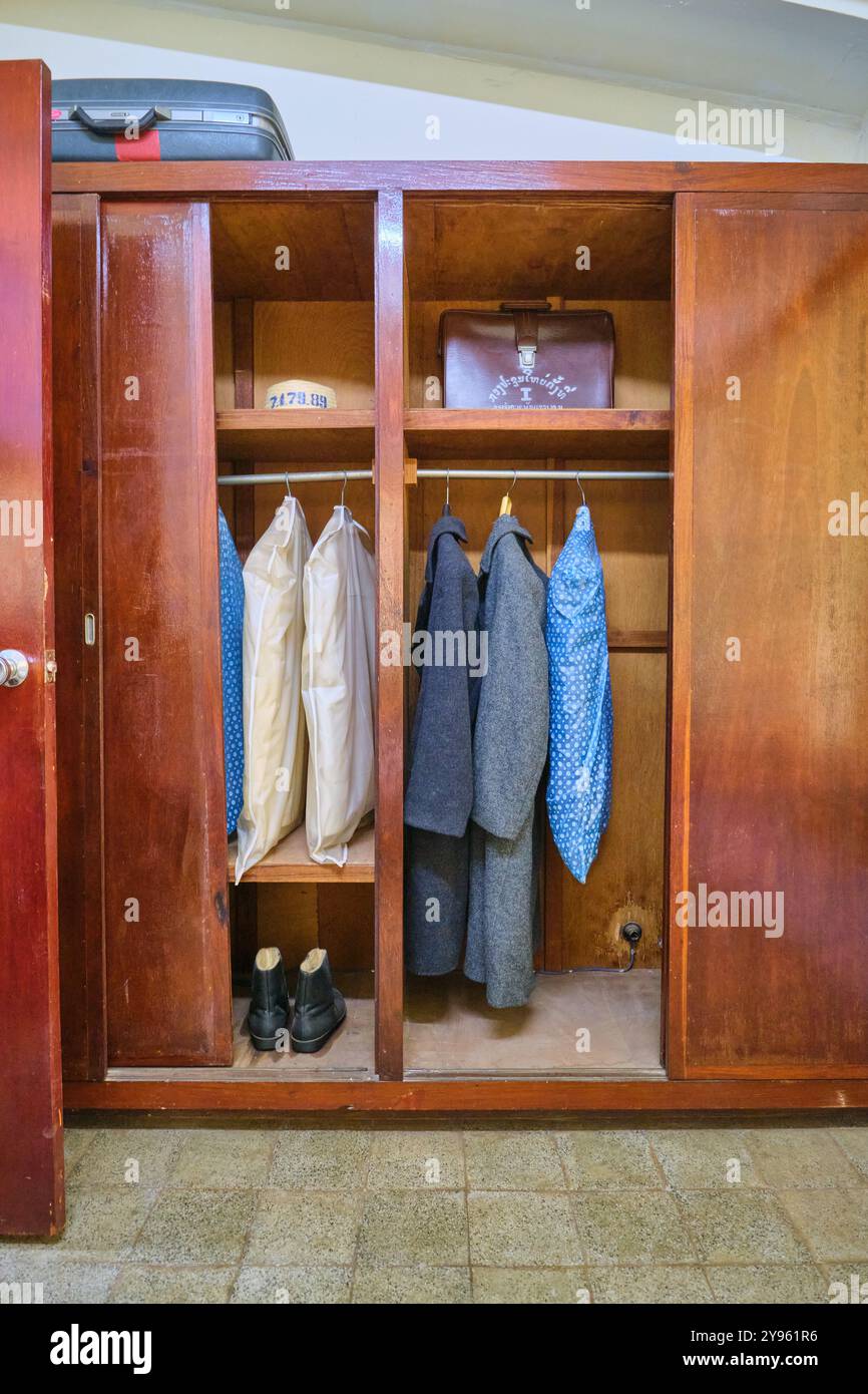 The closet, wardrobe with clothes, boots. At the cinder block home of ...