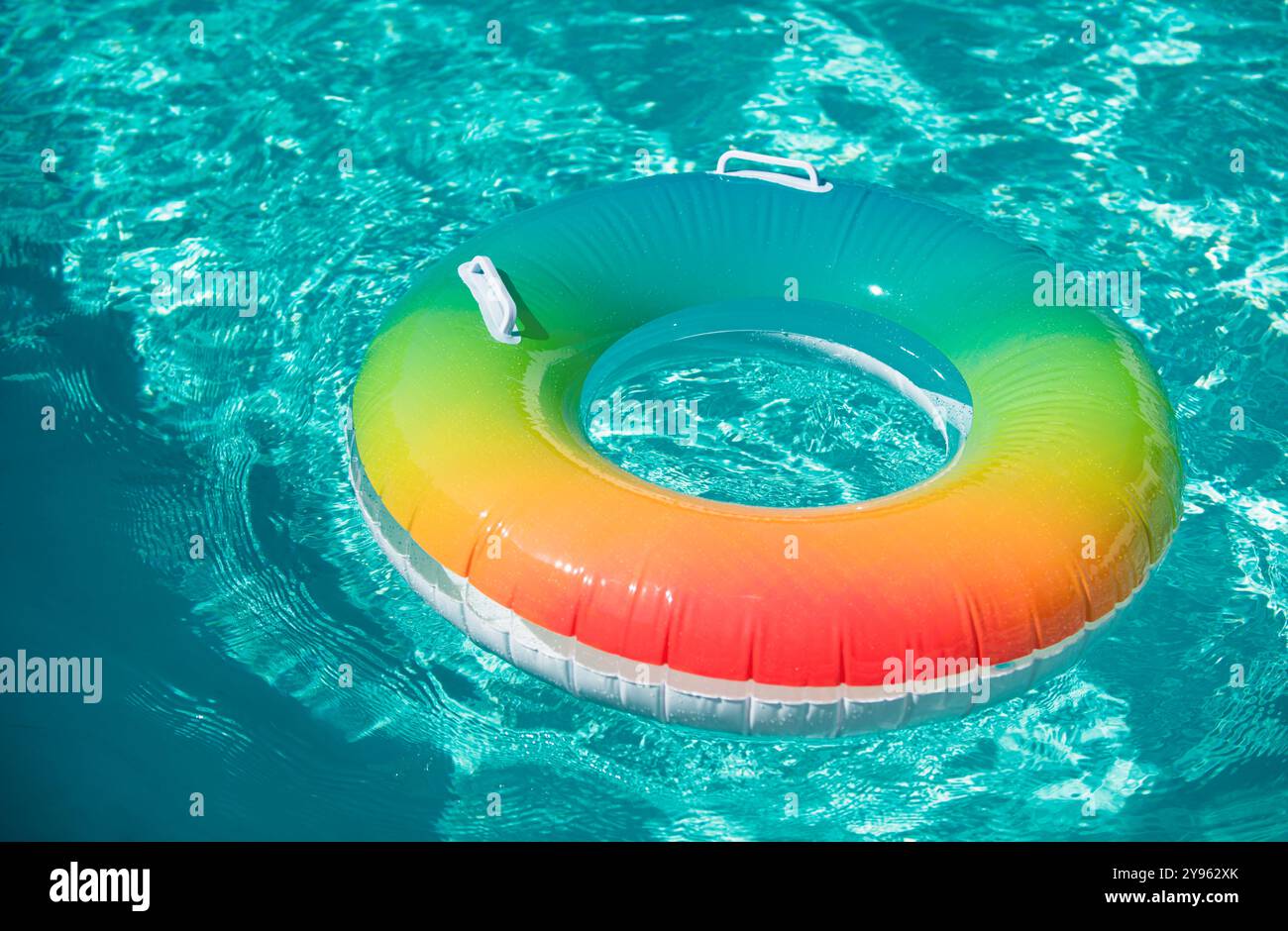Inflatable rubber ring floating in a blue water in pool Stock Photo - Alamy