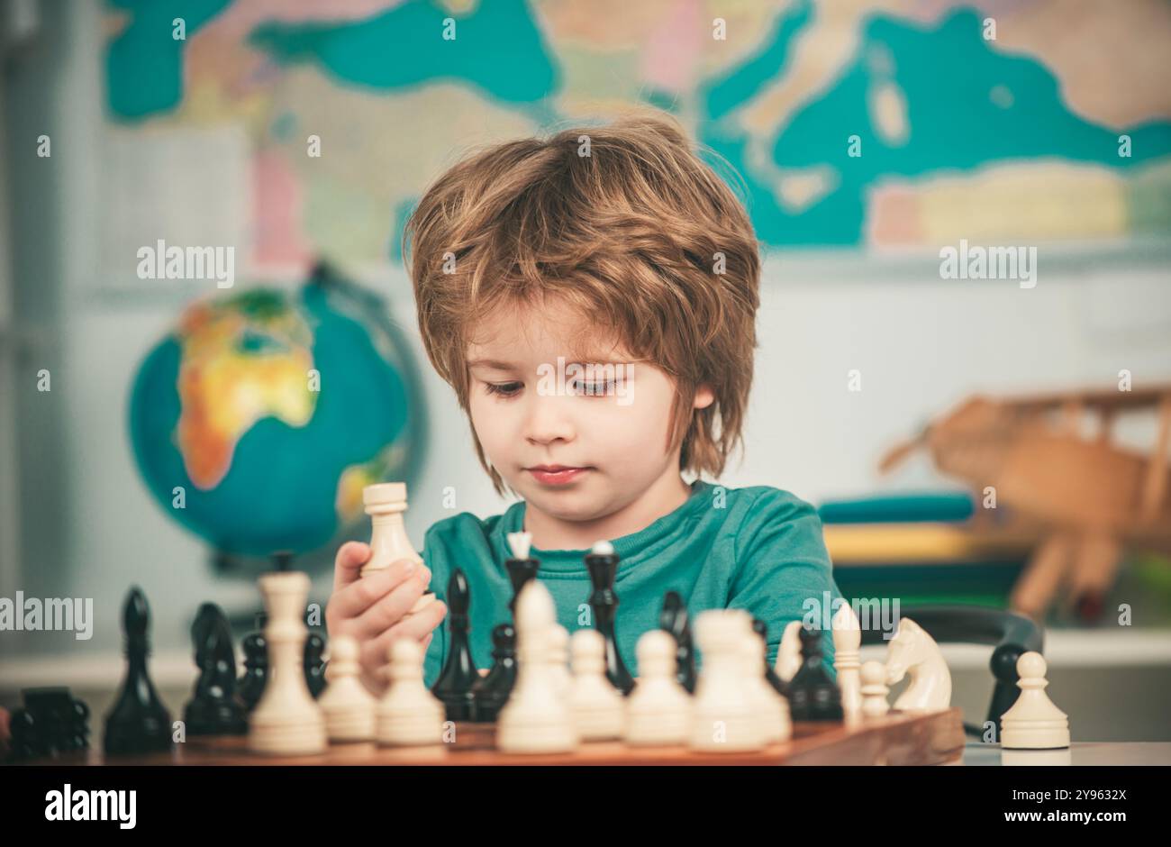 Preschooler or schoolboy, Thinking kid. Kid playing chess in the room ...