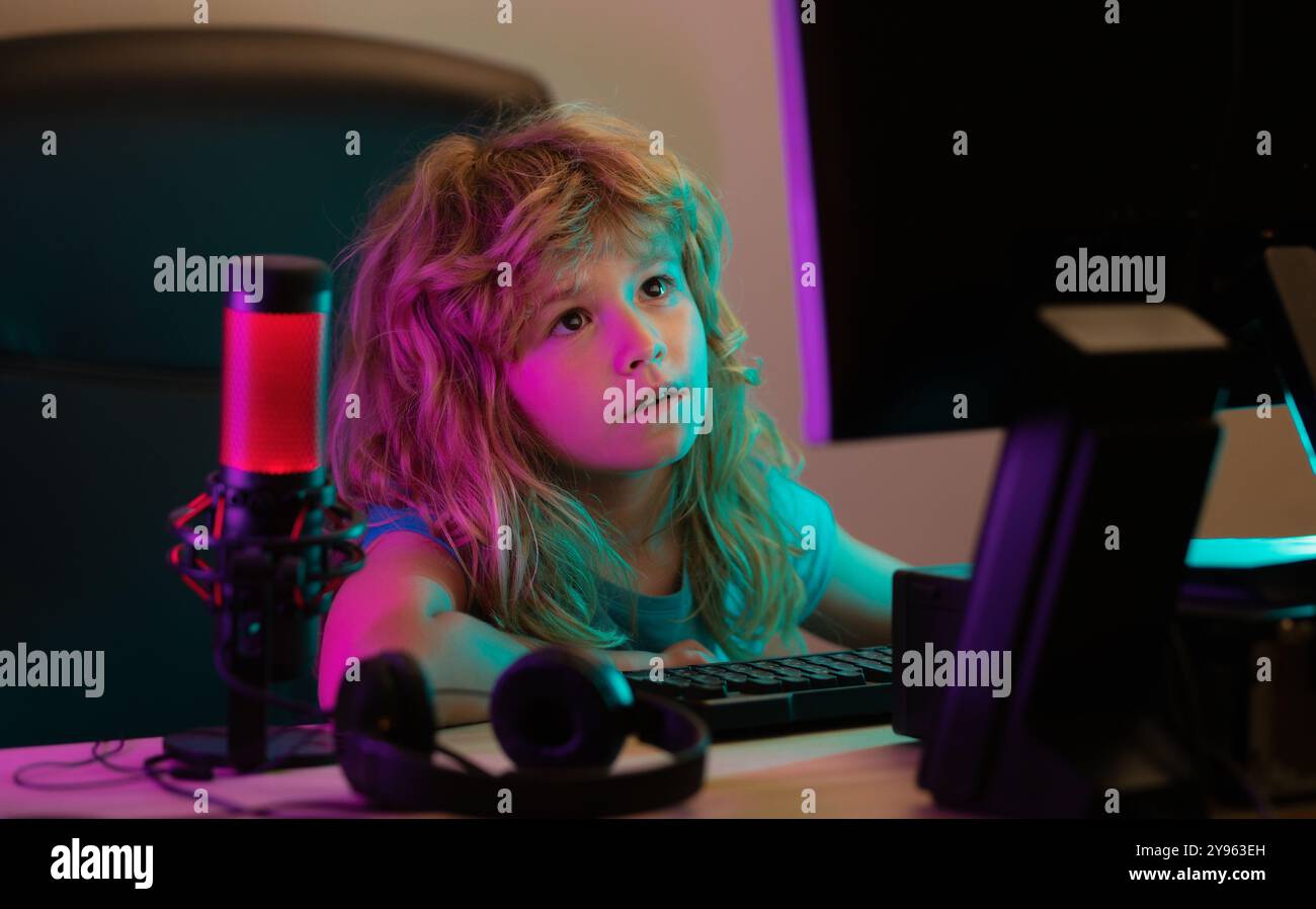 Kid using pc at night. Child with computer in a dark room. School ...