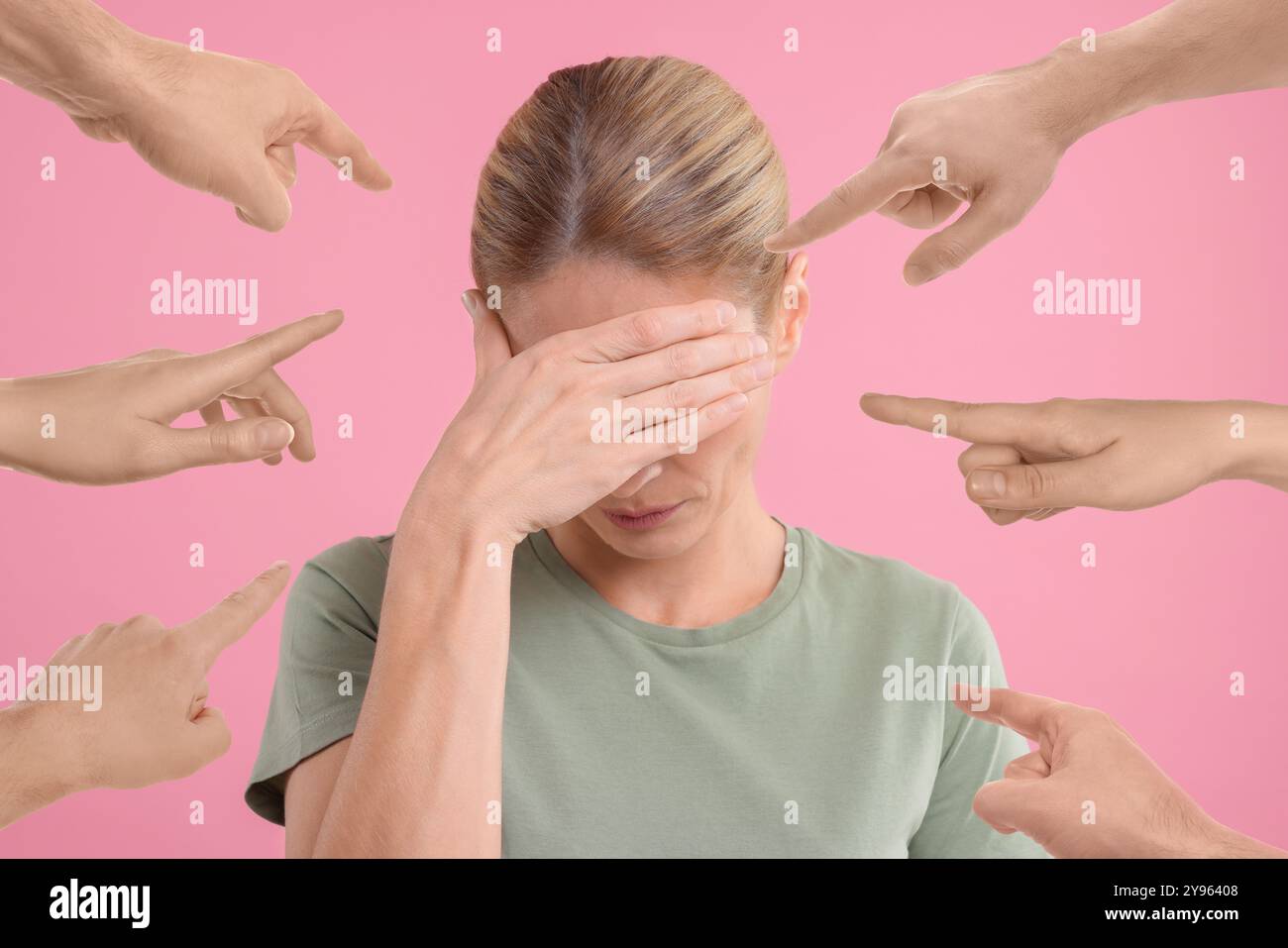 People pointing at embarrassed woman on pink background Stock Photo - Alamy