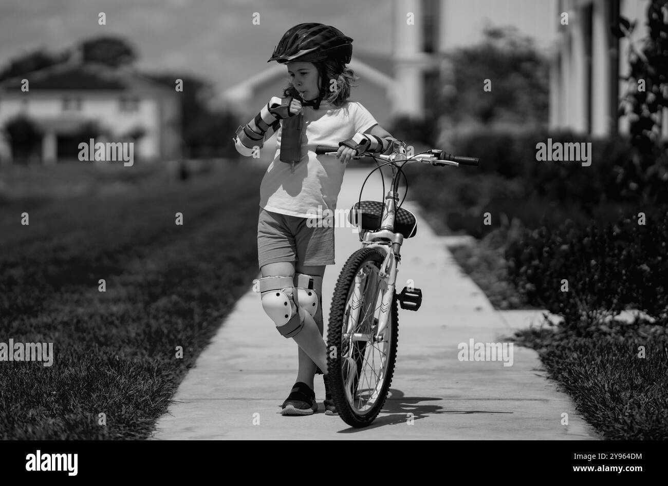Child riding a bike in summer park. Children learning to drive a ...