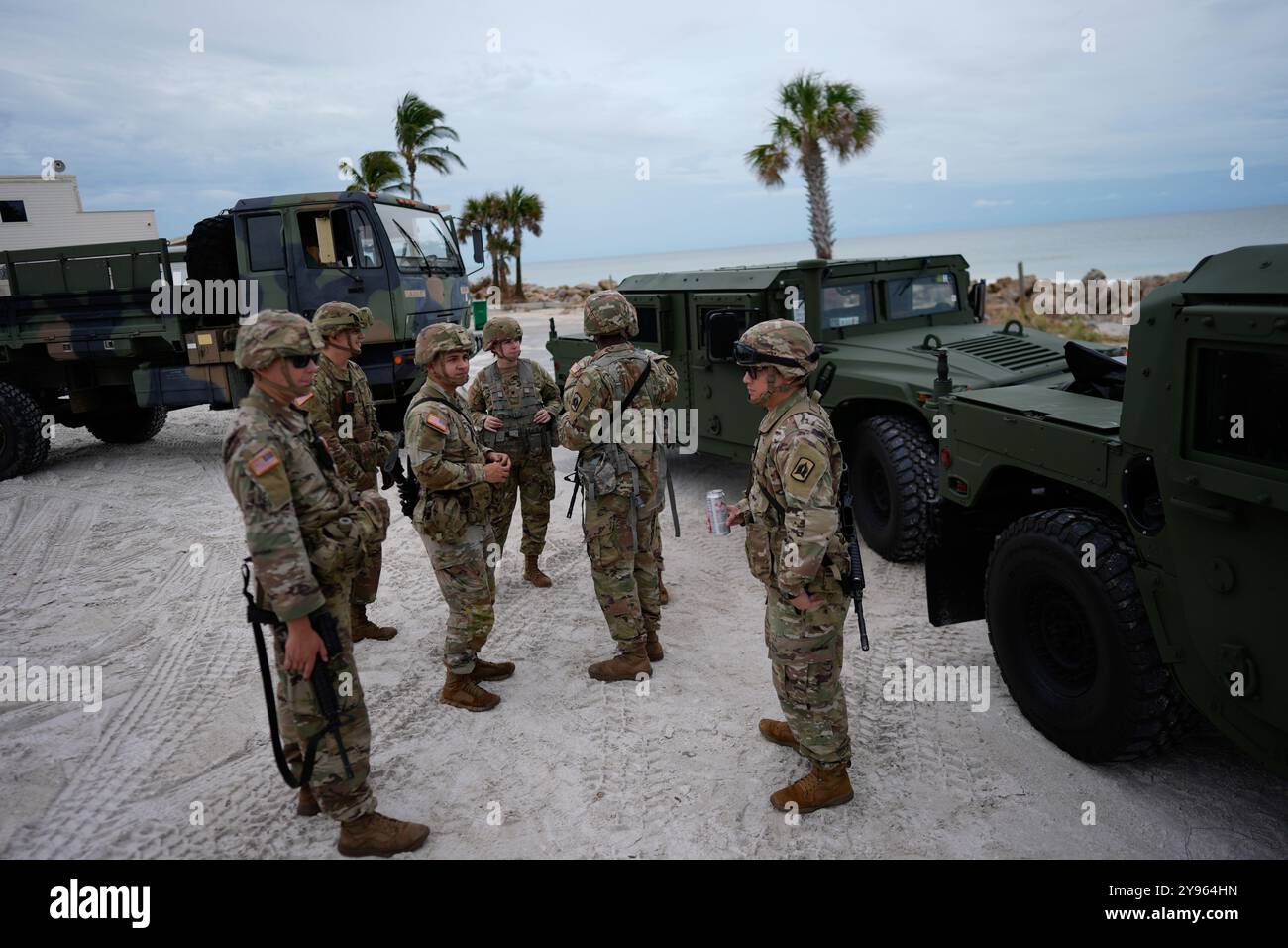 Members of the Florida Army National Guard stage on a beach as they ...