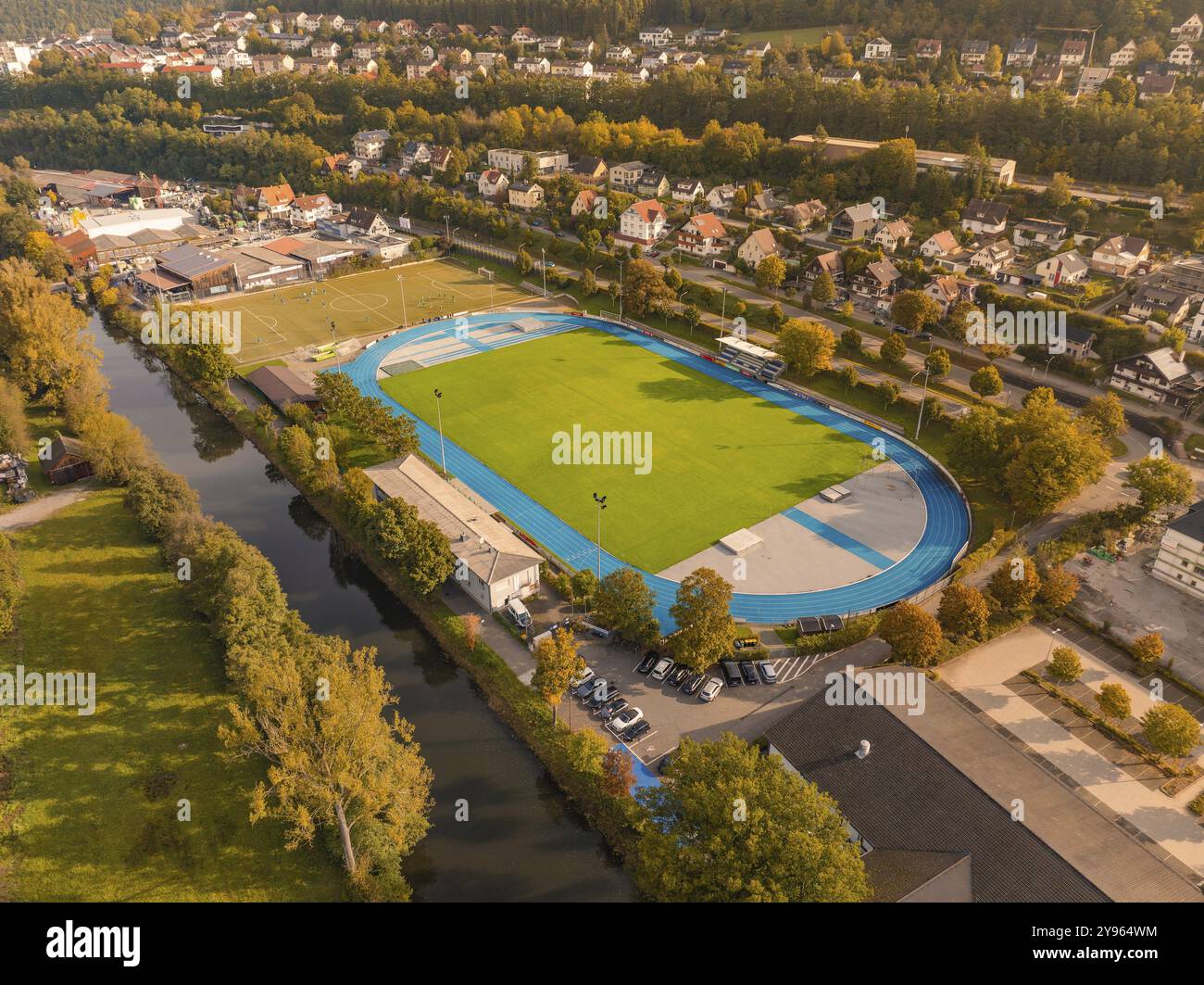 Aerial view of a stadium with a blue running track, surrounded by ...