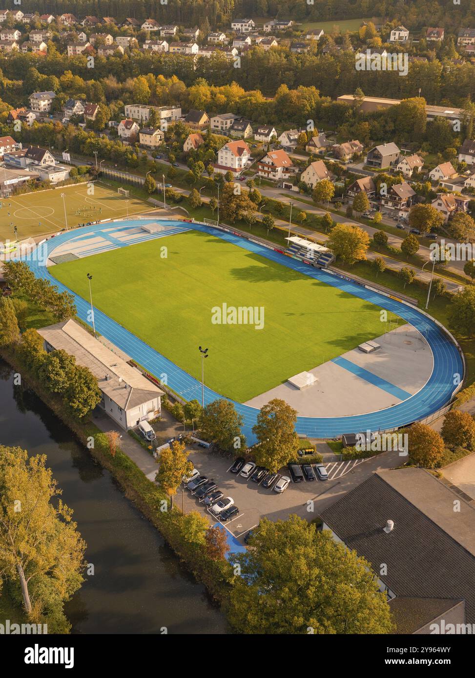 Sports field with blue running track, surrounded by residential area ...