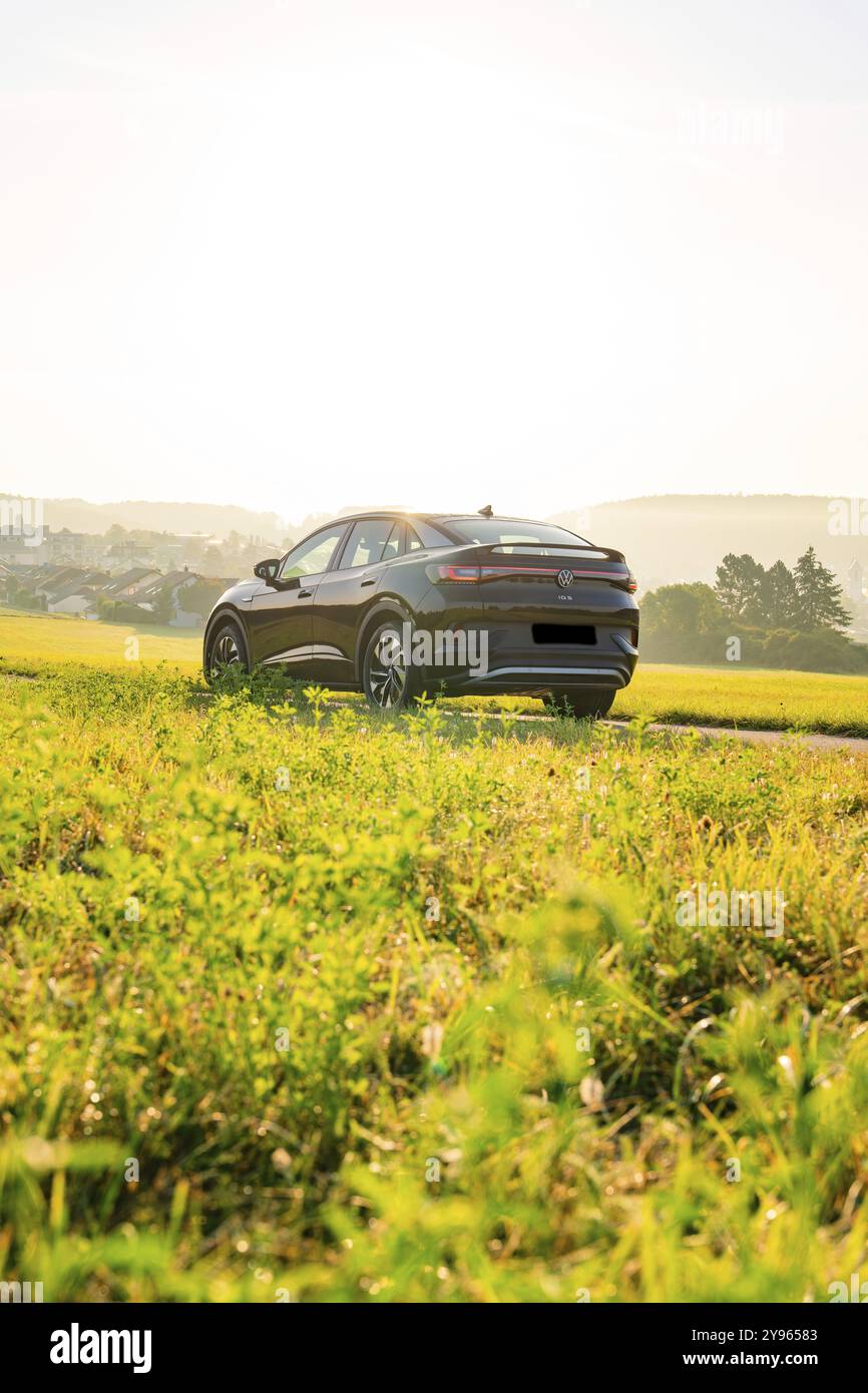 SUV driving through a green rural environment with a sunny background ...