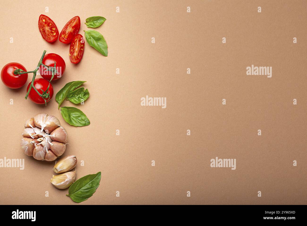 Food cooking border with cherry tomatoes, fresh green basil and garlic ...