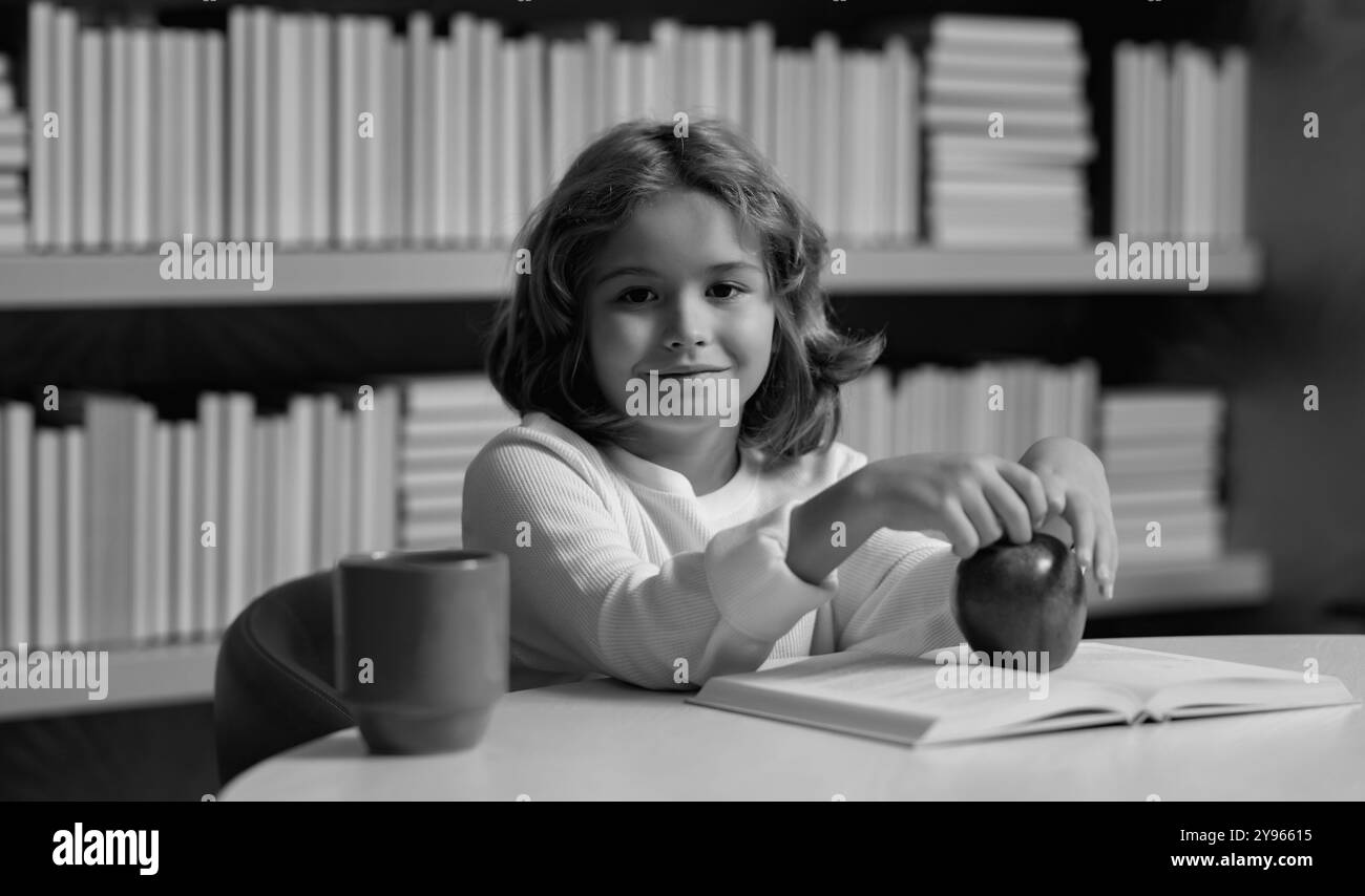 Pupil with book. Kid on school library. Child reading book at school ...