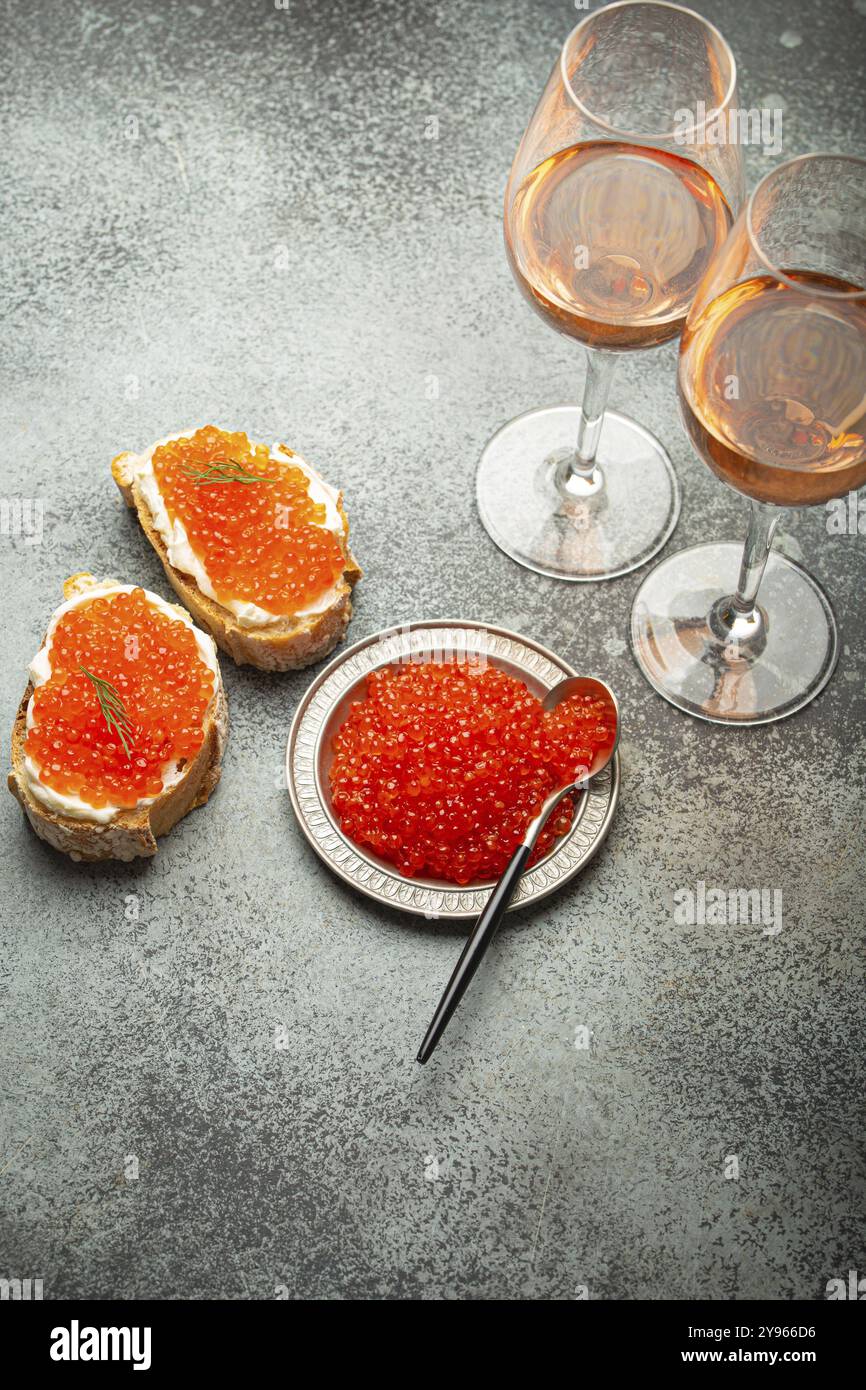 Small metal plate with red salmon caviar, two caviar toasts canape, two ...