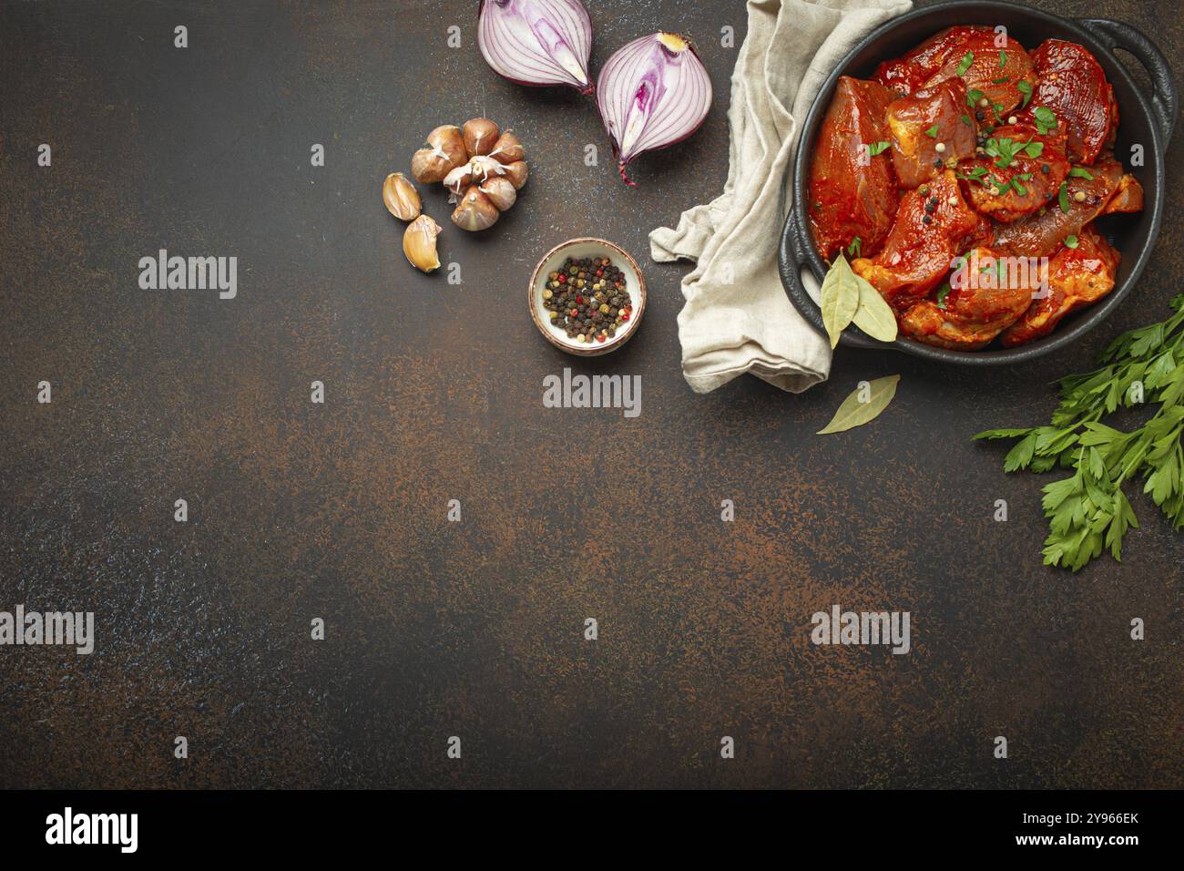 Cooking hearty meat stew. Raw uncooked chopped pieces of meat marinated ...