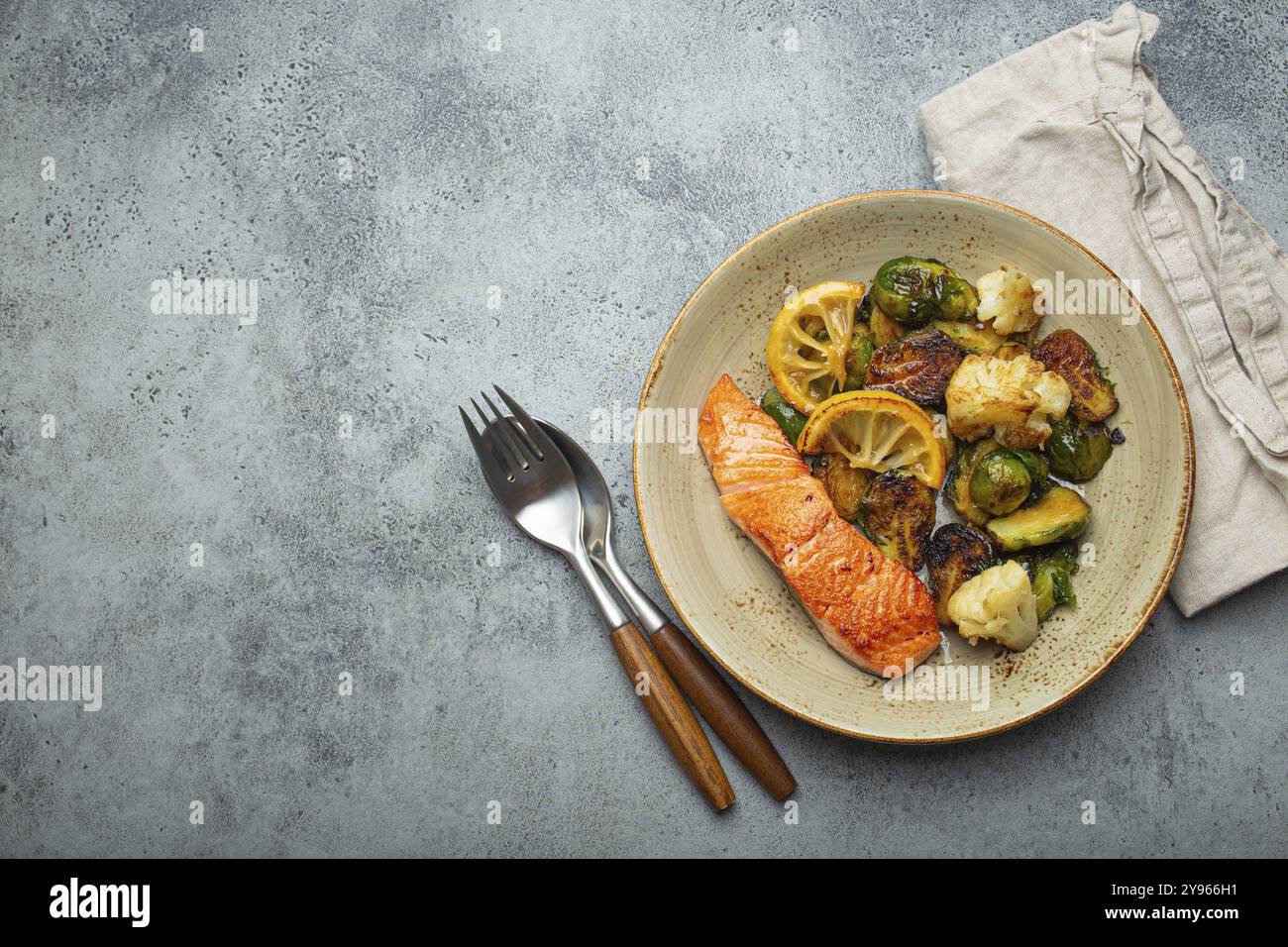 Delicious salmon fillet with grilled Brussels sprouts on plate, rustic ...