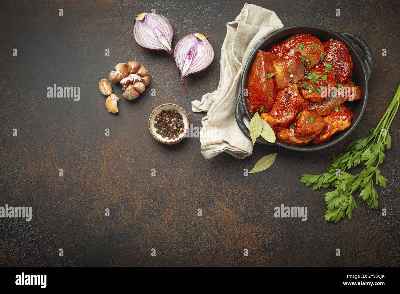 Cooking hearty meat stew. Raw uncooked chopped pieces of meat marinated ...