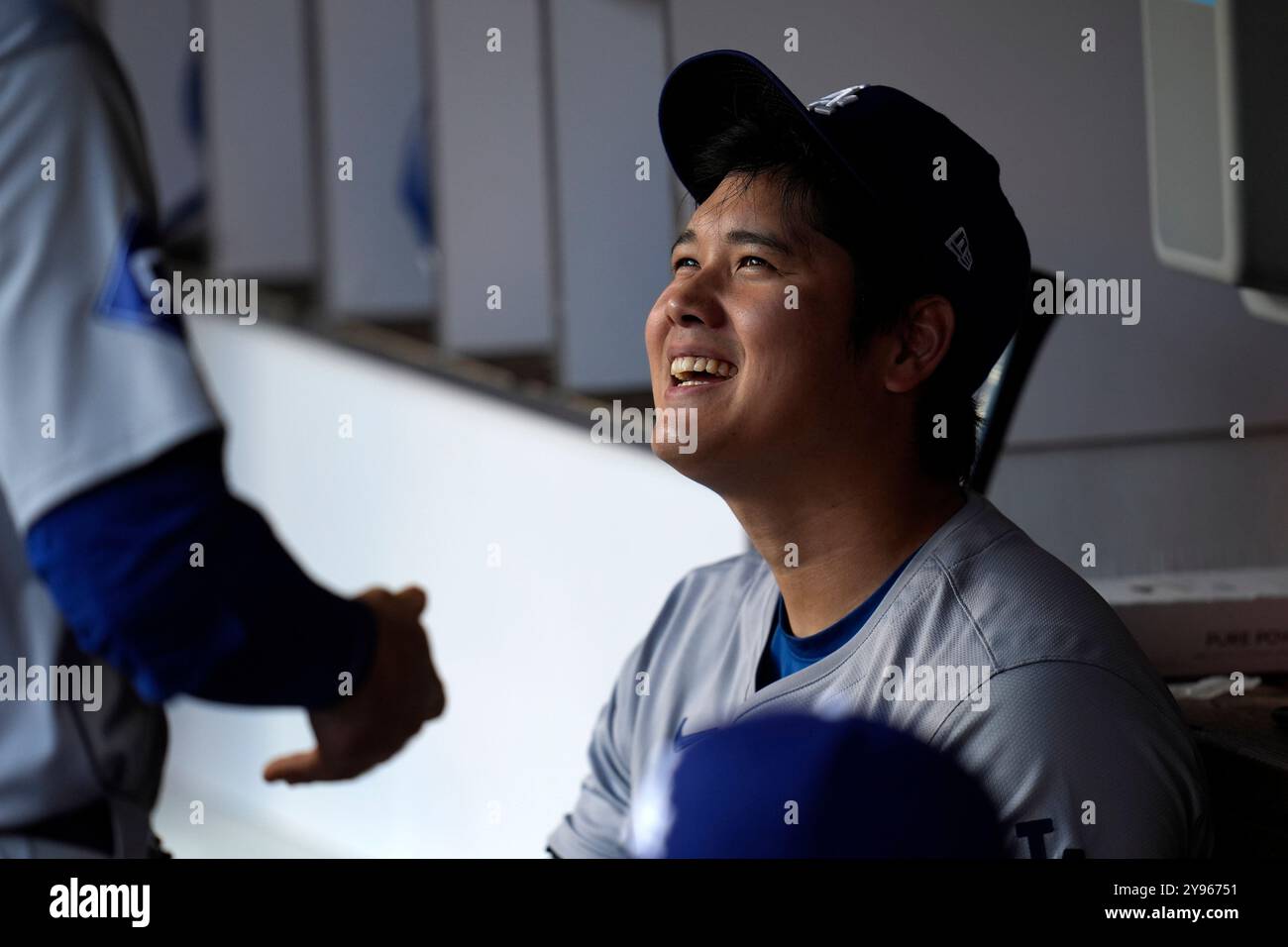 Los Angeles Dodgers' Shohei Ohtani smiles in the dugout before Game 3 ...