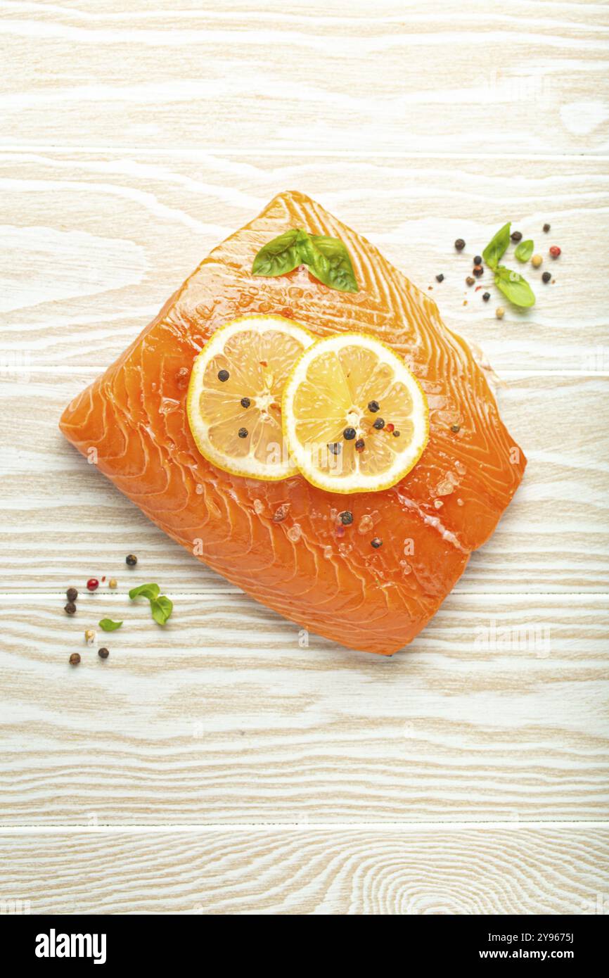Fresh raw salmon marbled fillet on white rustic wooden table background ...