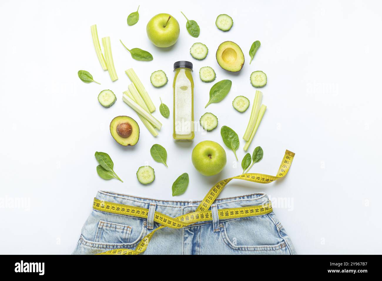 Green fruit, vegetables, smoothie falling into jeans and yellow ...