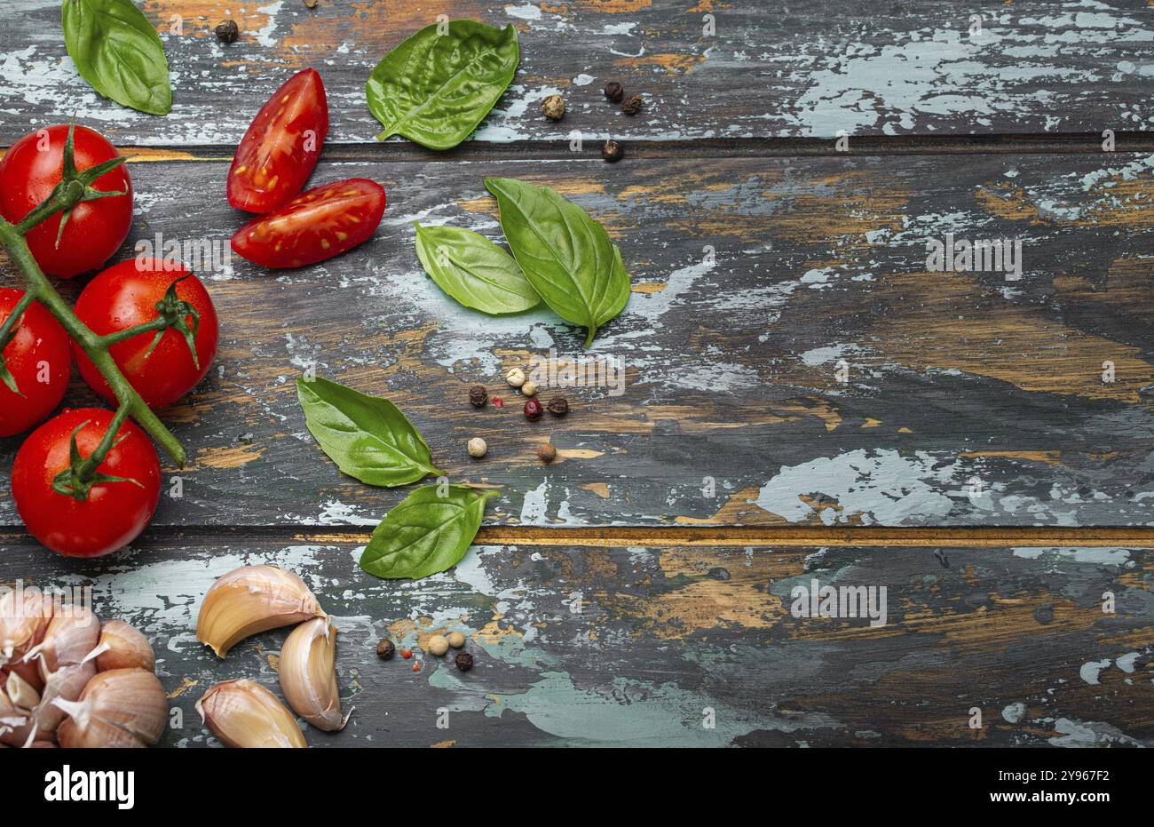 Food cooking border with cherry tomatoes, fresh green basil and garlic ...