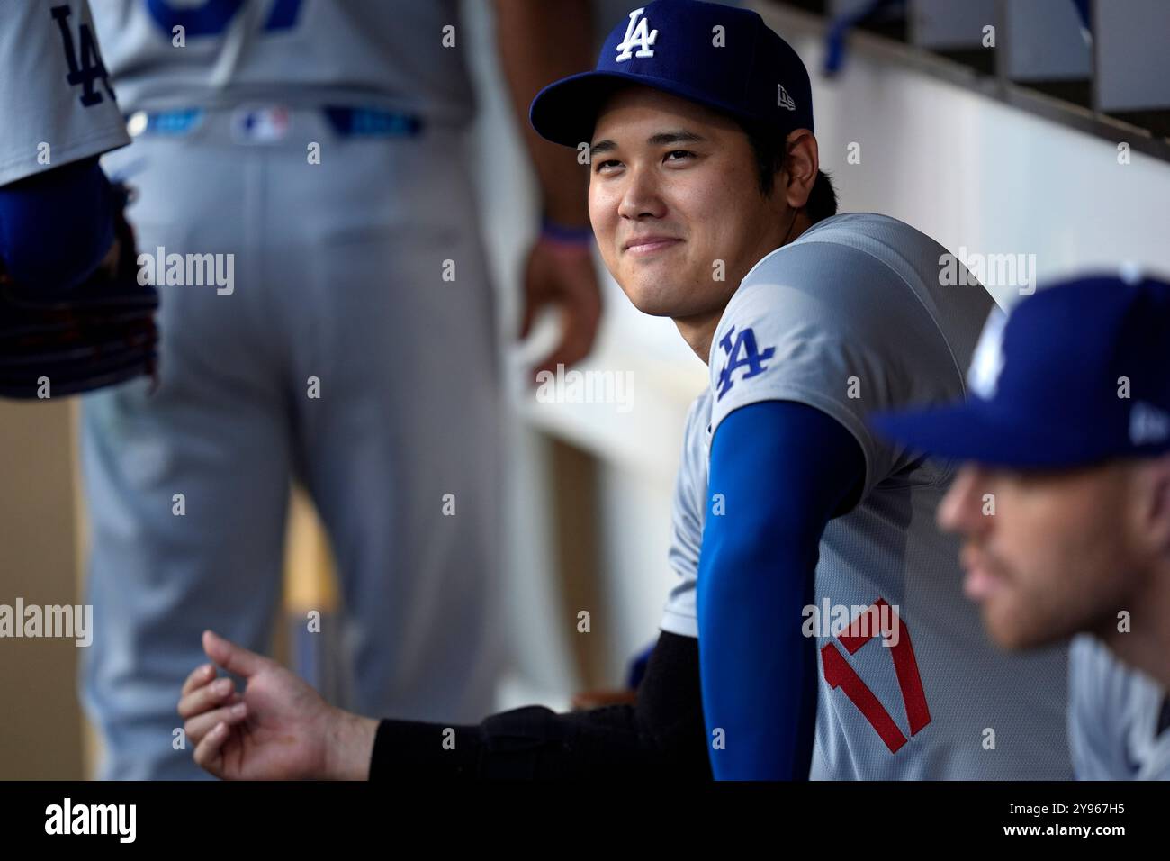 Los Angeles Dodgers' Shohei Ohtani smiles in the dugout before Game 3 ...